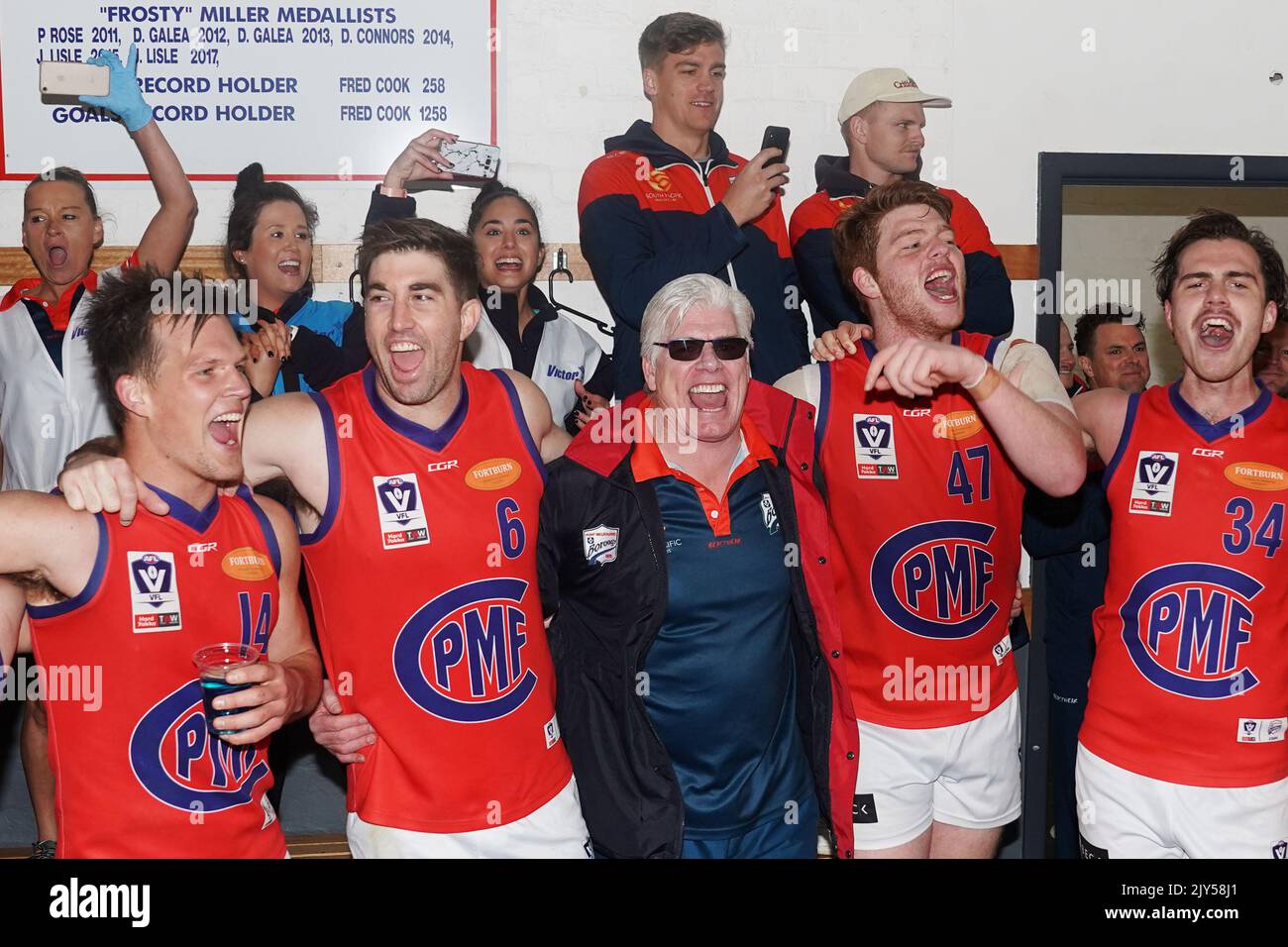 Port coach Gary Ayres sing the club song after winning with players ...