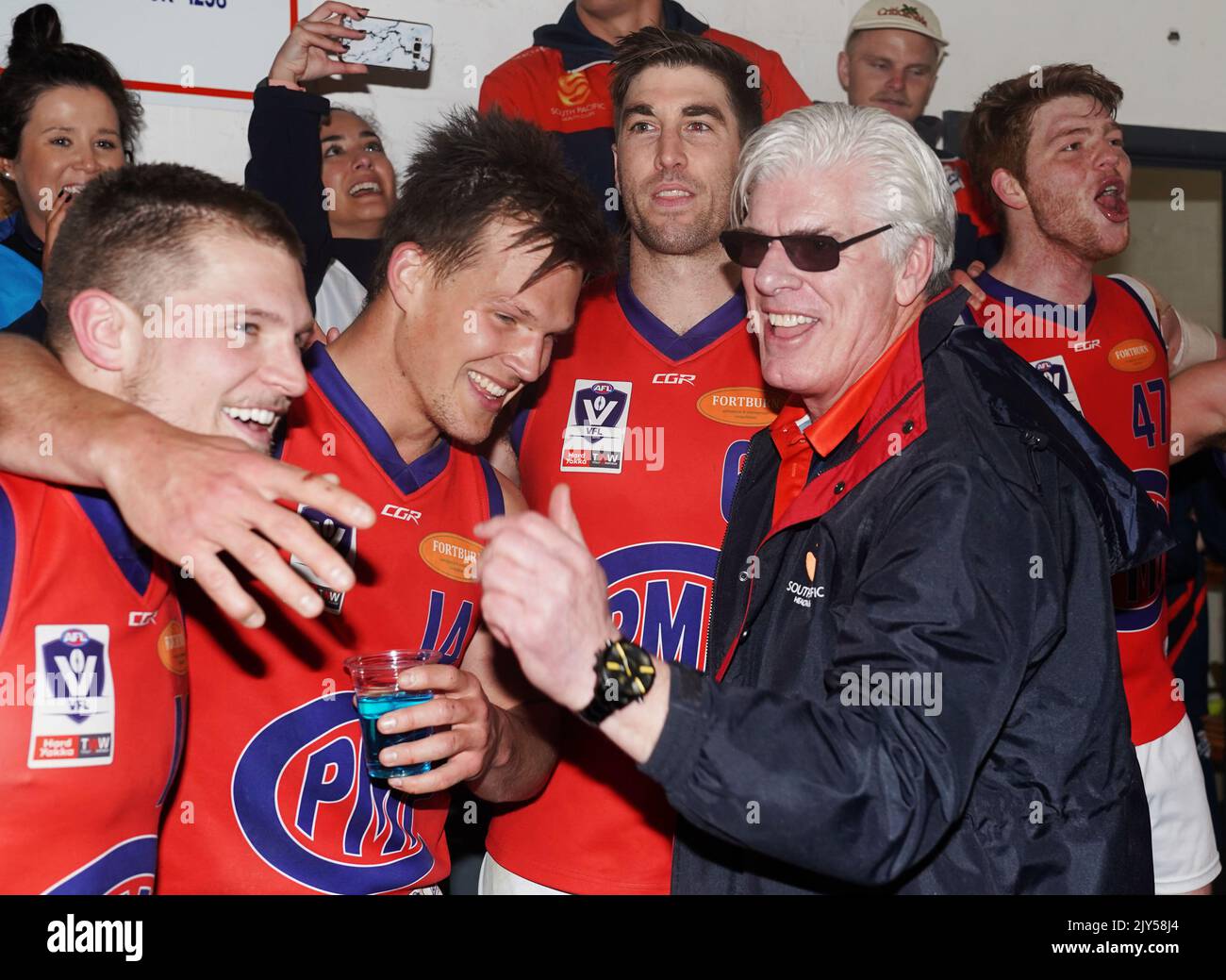 Port coach Gary Ayres sing the club song after winning with players ...
