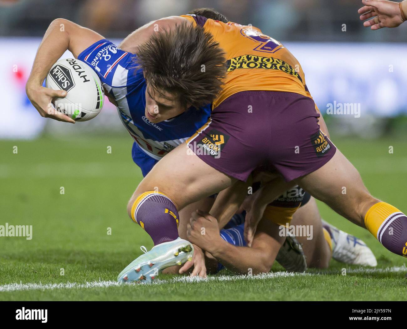 Lachlan Lewis of the Bulldogs is tackled during the Round 25 NRL match ...