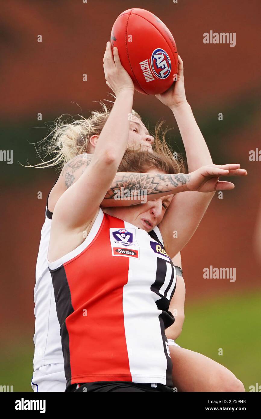 Hannah Stuart of the Saints marks the ball against Nicole Julian of Melbourne Uni during the ...