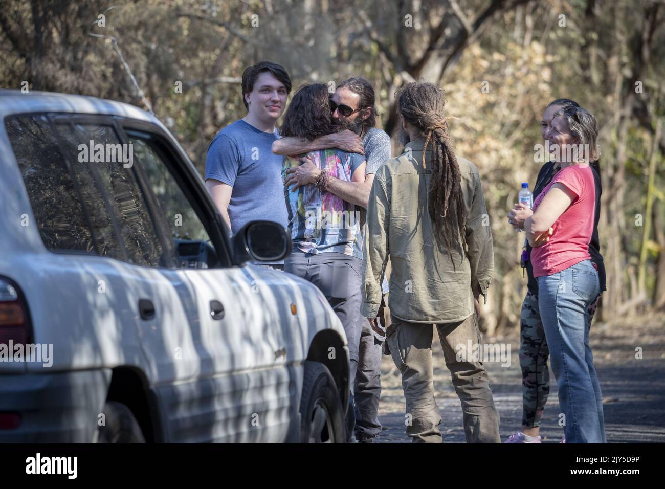 Lisa Groom (second from left) is comforted by friends on Binna Burra ...
