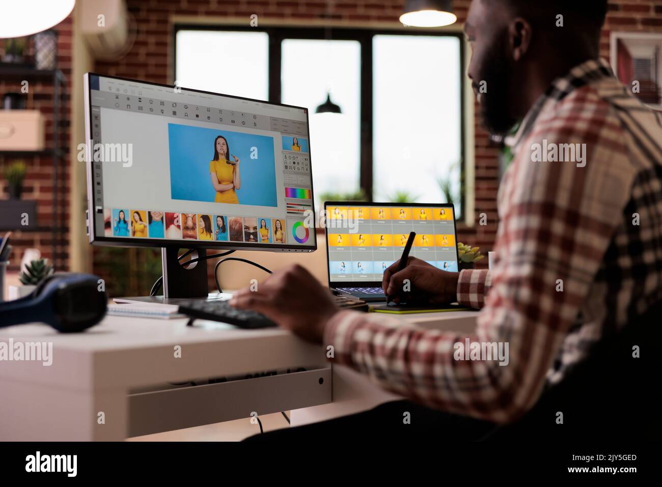 Content creator editing picture with retoucher software on computer ...