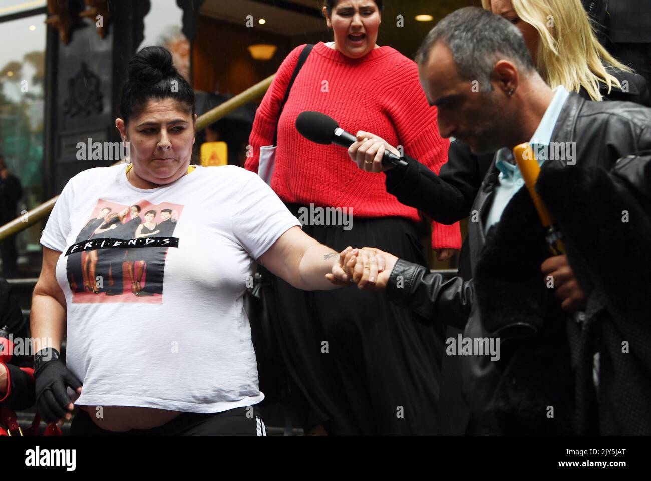 Alison Mains (left) is helped by a friend as she leaves the Downing ...