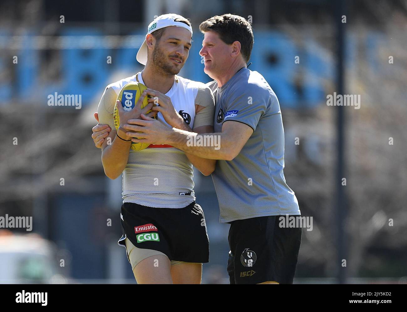 James Aish (left) and assistant coach Robert Harvey of the Collingwood ...