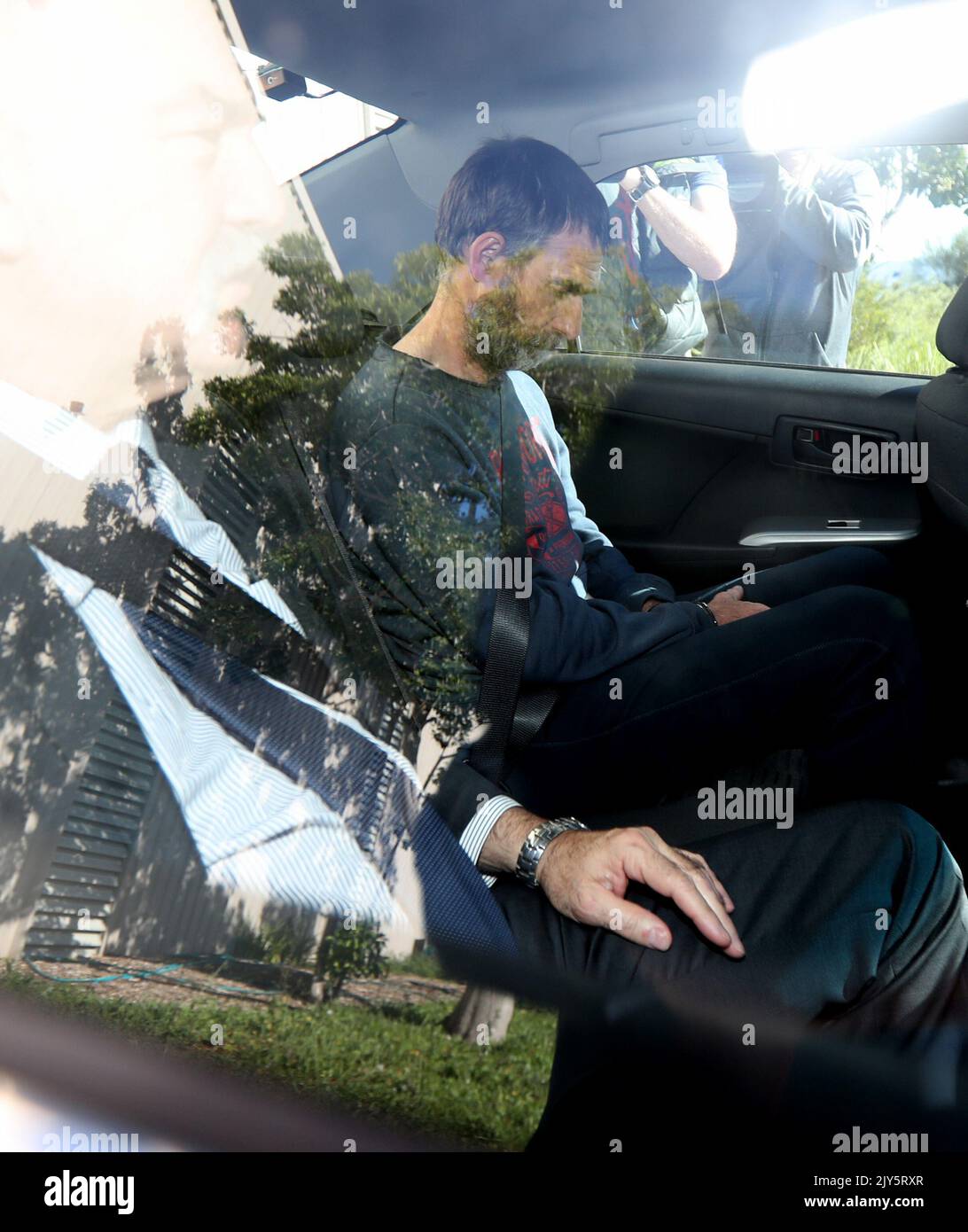 Matthew Tilley is seen with police leaving the Adelaide Airport in ...