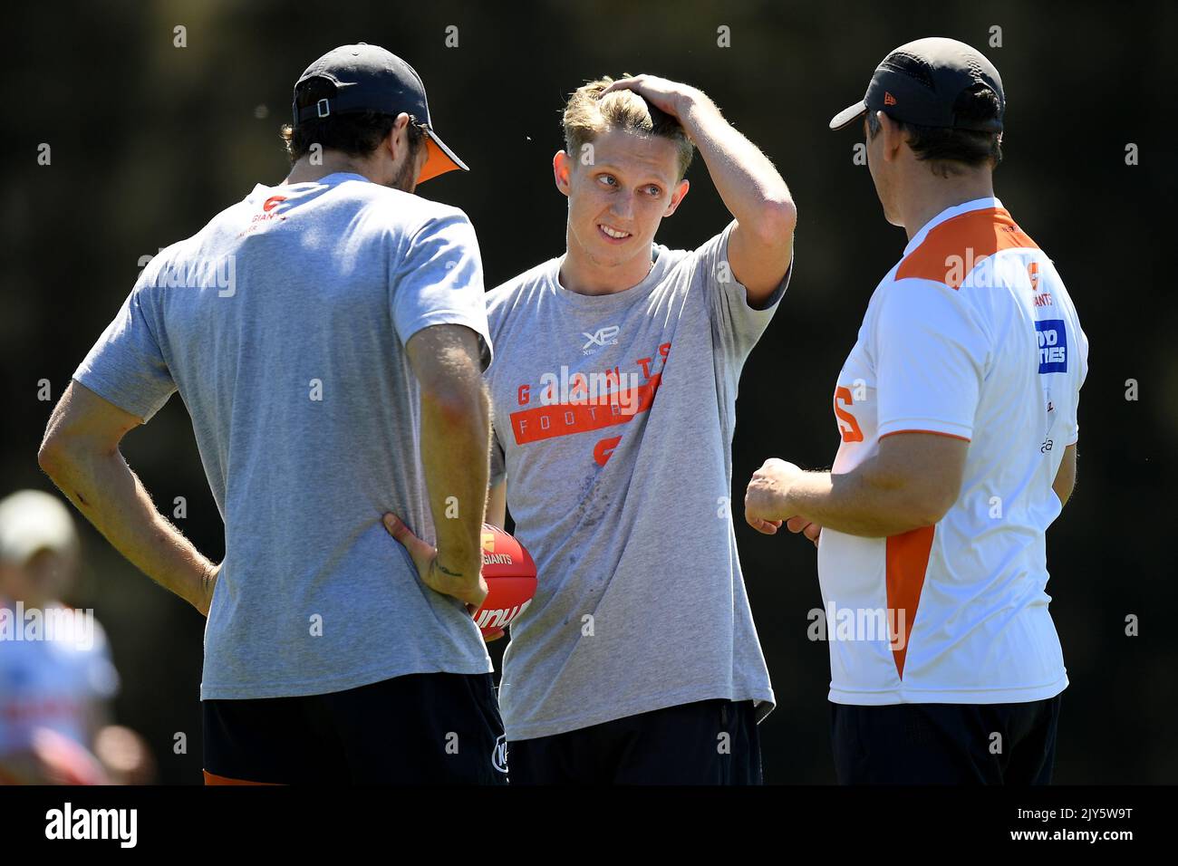 Lachie Whitfield of the Giants (centre) speaks with Shane Mumford (left ...