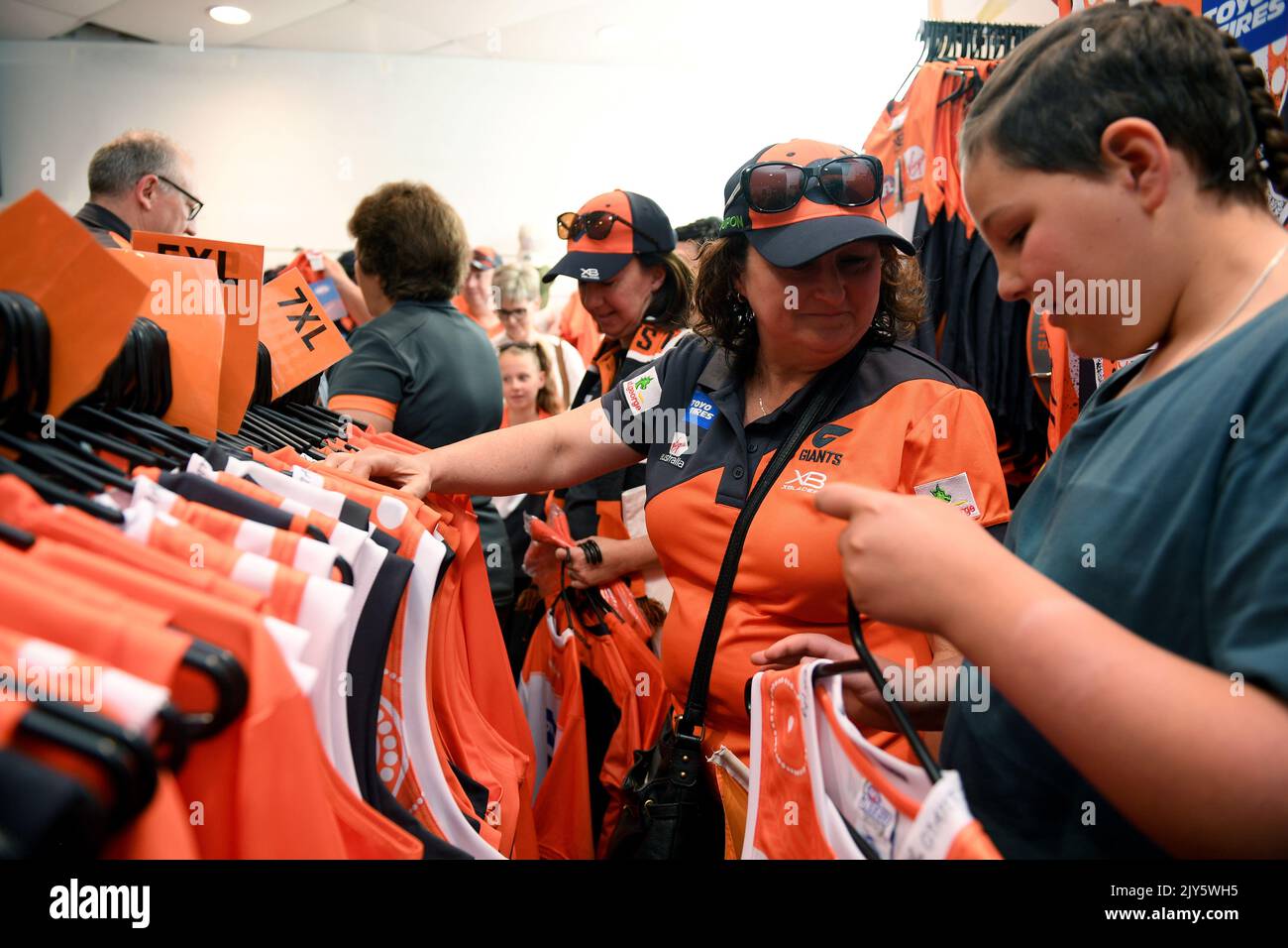 Supporters crowd the GWS Giants store ahead of a training session at ...