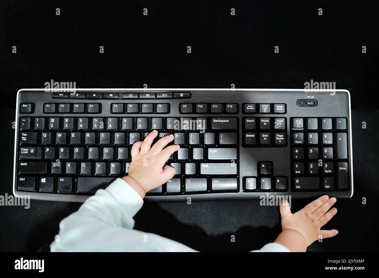 Baby touching laptop keyboard hi-res stock photography and images - Alamy