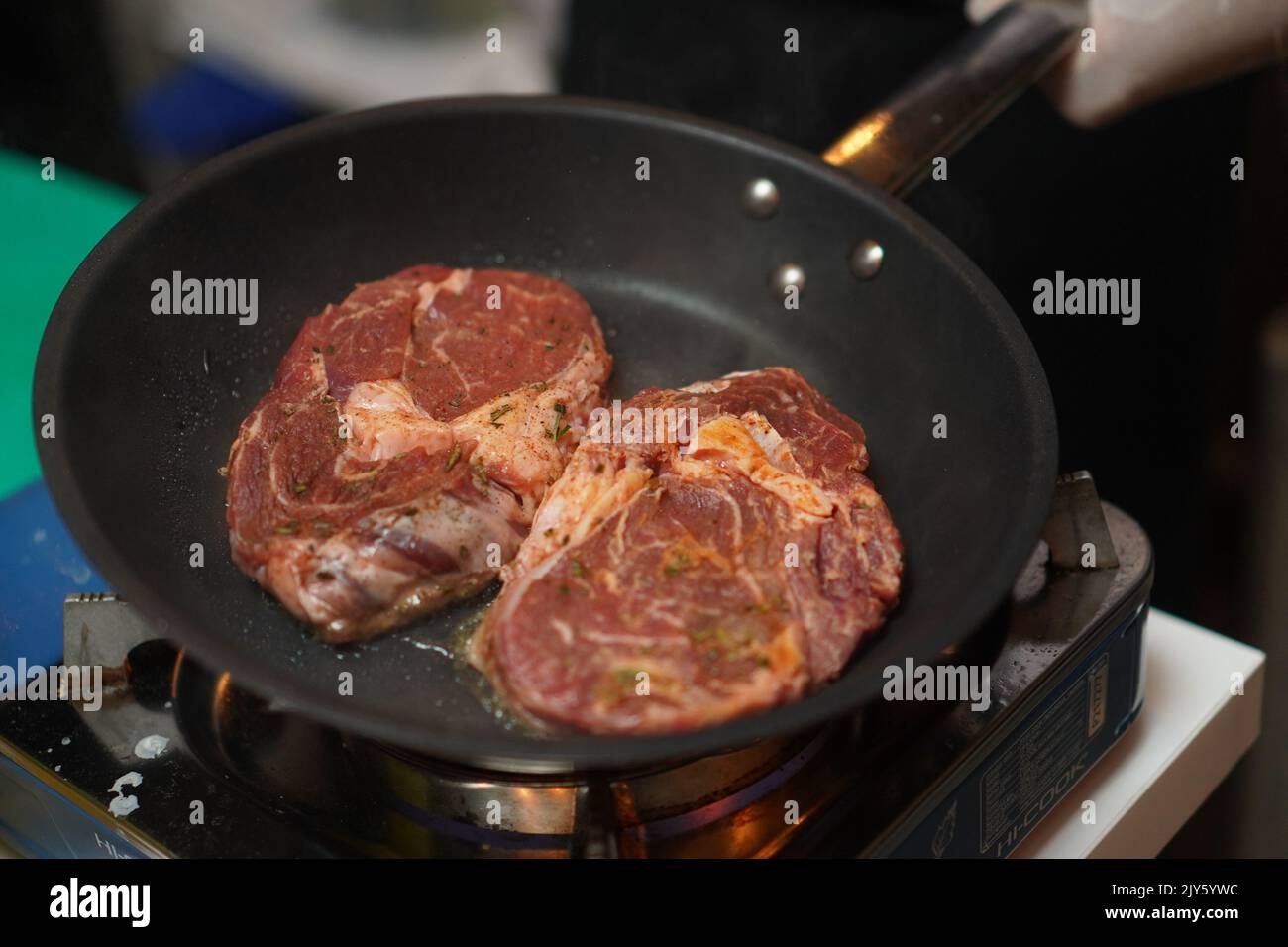 Cooking delicious beef steak in frying pan Stock Photo - Alamy
