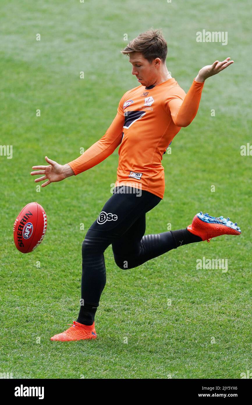 Toby Greene of the Giants kicks the ball during a GWS Giants AFL ...