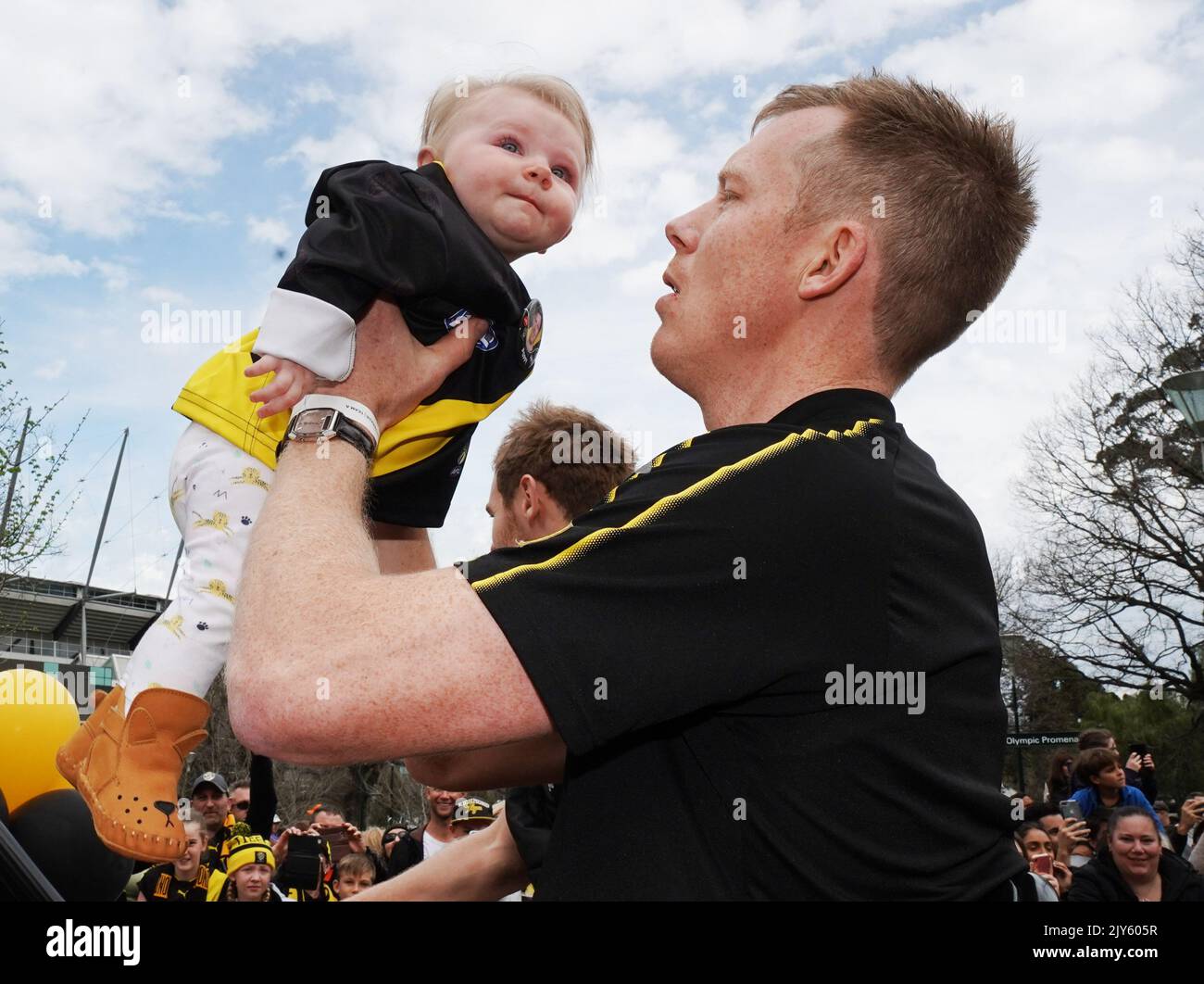Jack Riewoldt of the Tigers enjoys the parade with his daughter during ...