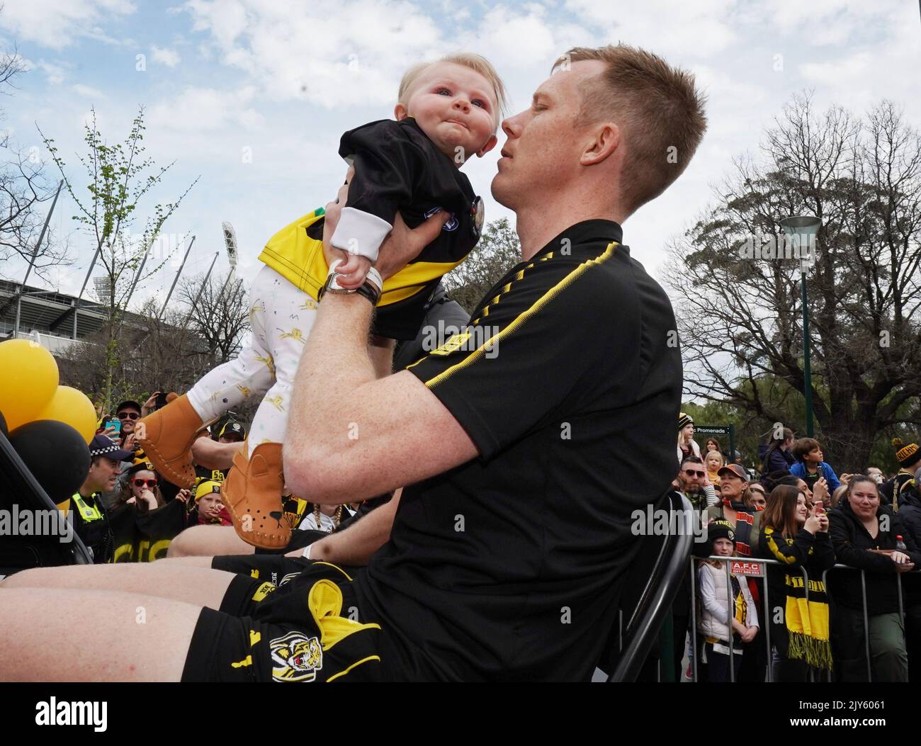 Jack Riewoldt of the Tigers enjoys the parade with his daughter during ...