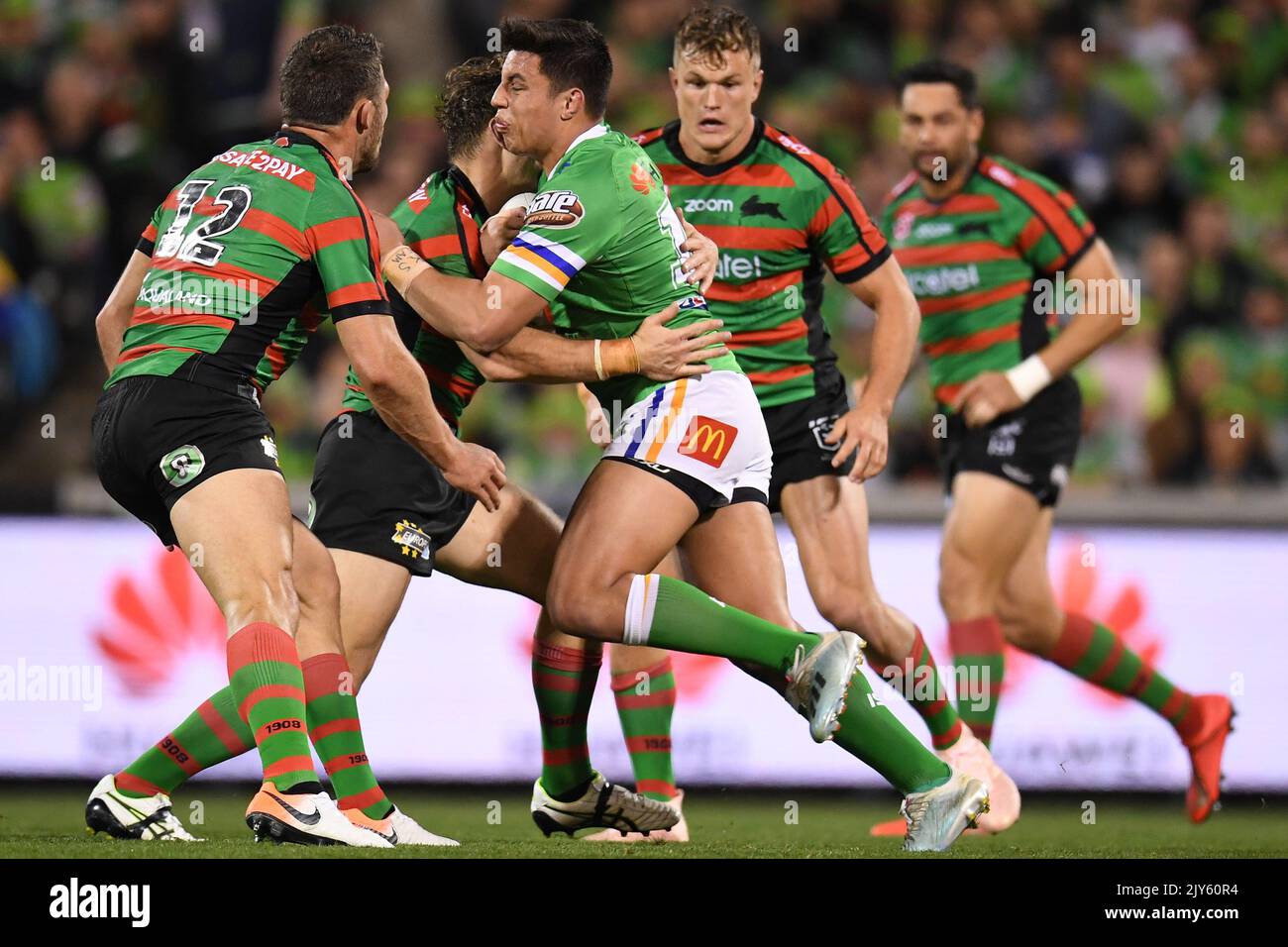 Joseph Tapine of the Raiders trees to push through the Rabbitohs ...