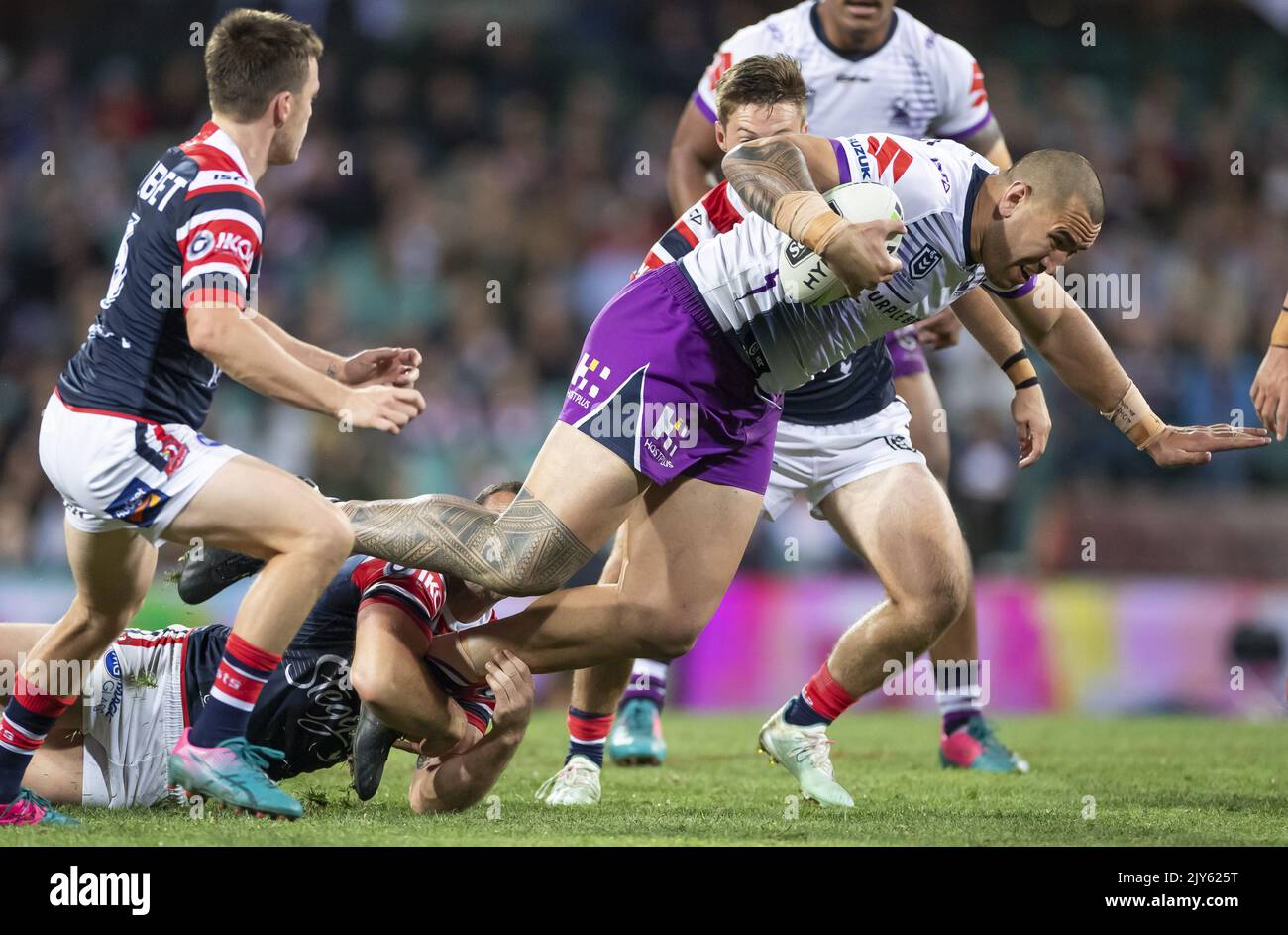 Nelson Asofa-Solomona of the Storm is tackled during the NRL ...