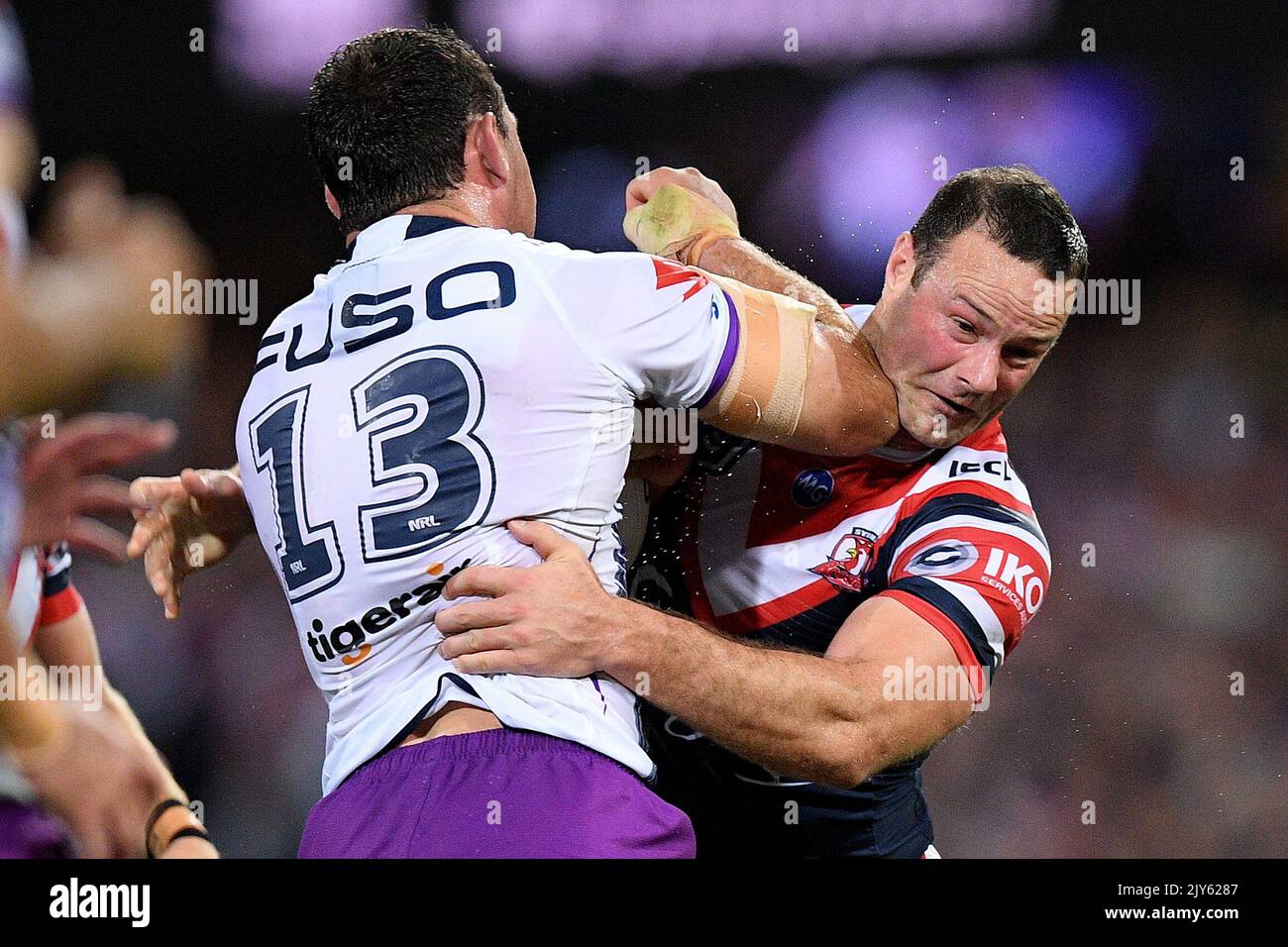 Dale Finucane of the Storm is tackled by Boyd Cordner of the Roosters ...