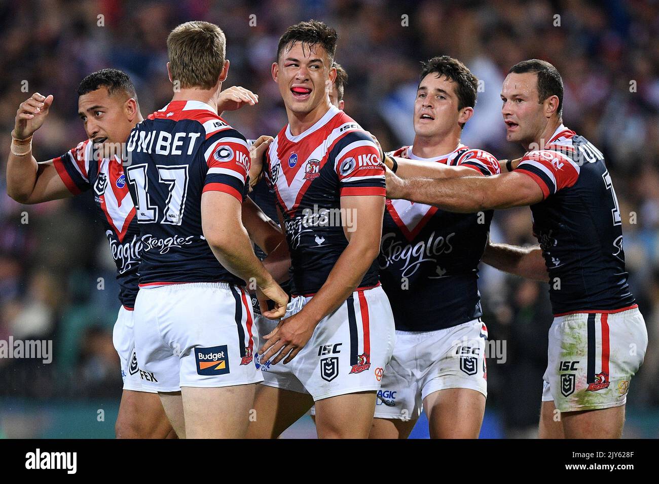 Joseph Manu of the Roosters (centre) celebrates with teammates after ...