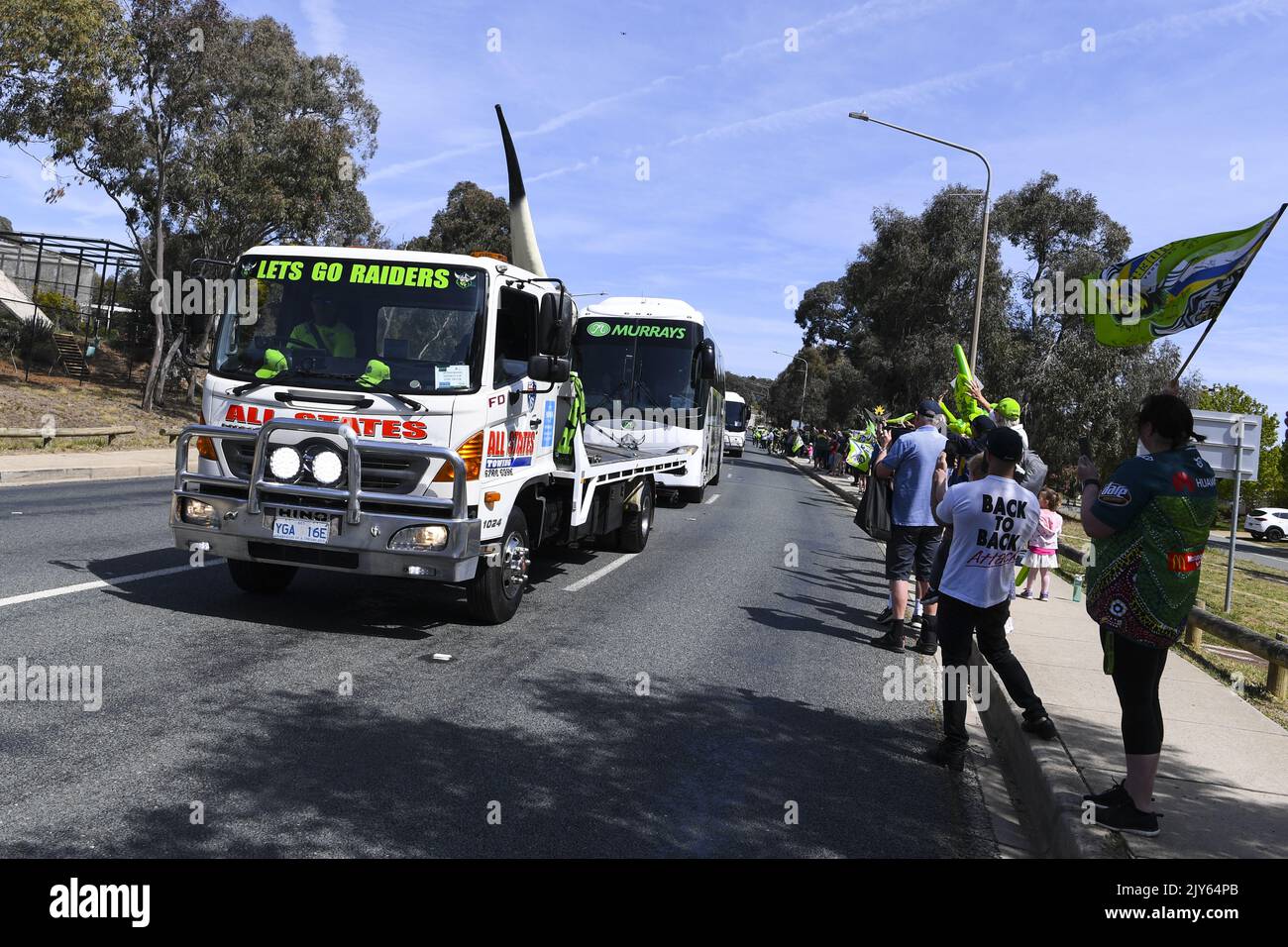 Raiders fans cheer as the Canberra Raiders team bus leaves the Canberra ...
