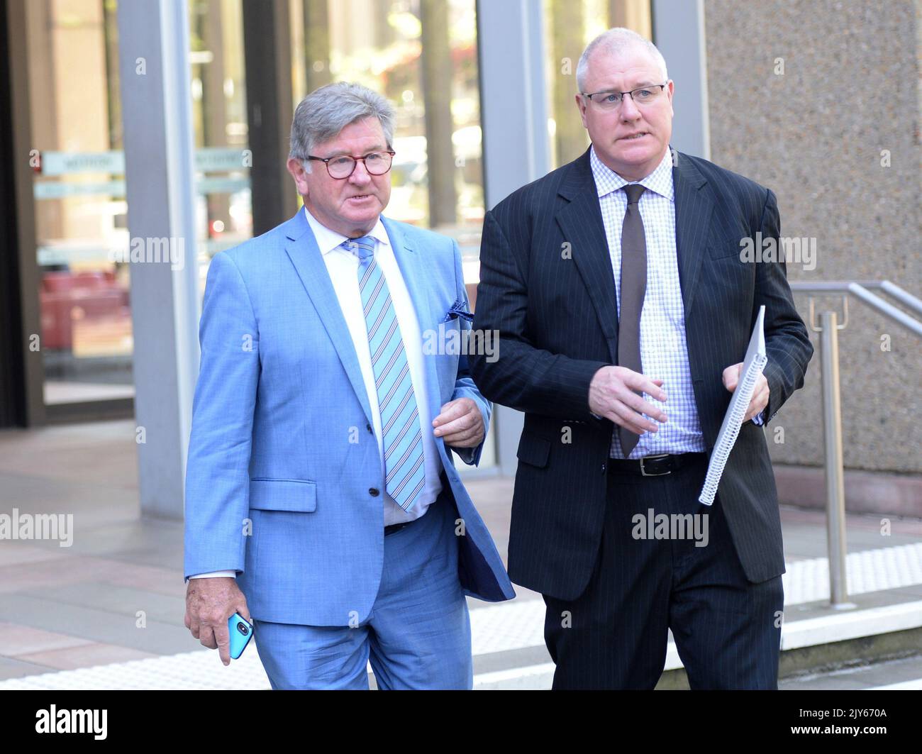 Journalist Stephen Barrett (left) arrives at the Supreme Court of NSW ...