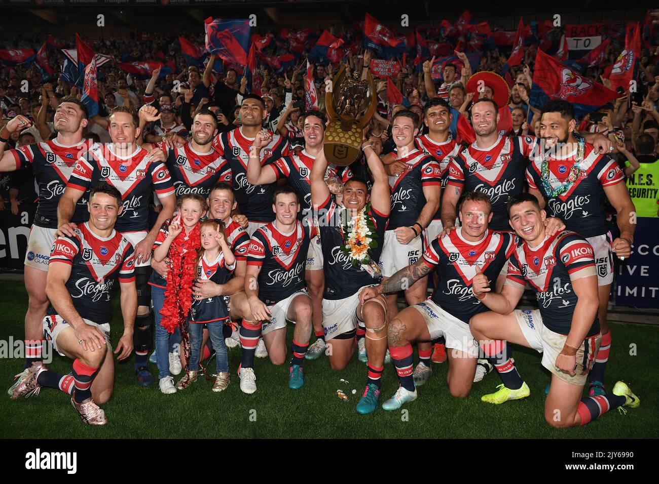 Sydney Roosters players celebrate with the Provan-Summons Trophy during ...