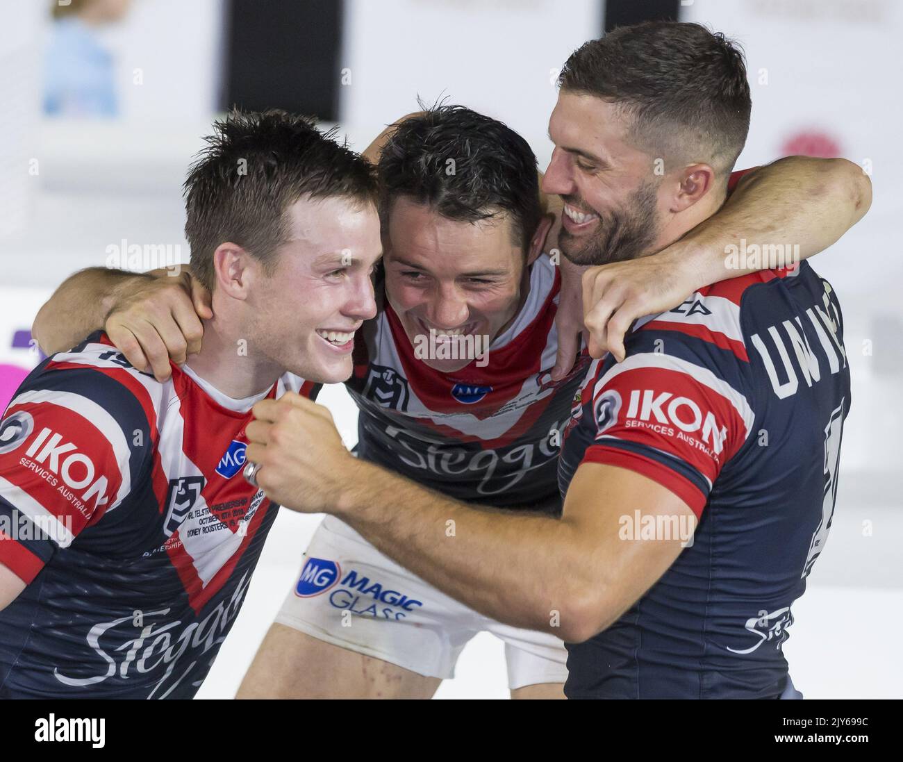 Luke Keary, Cooper Cronk and James Tedesco of the Roosters hug after ...