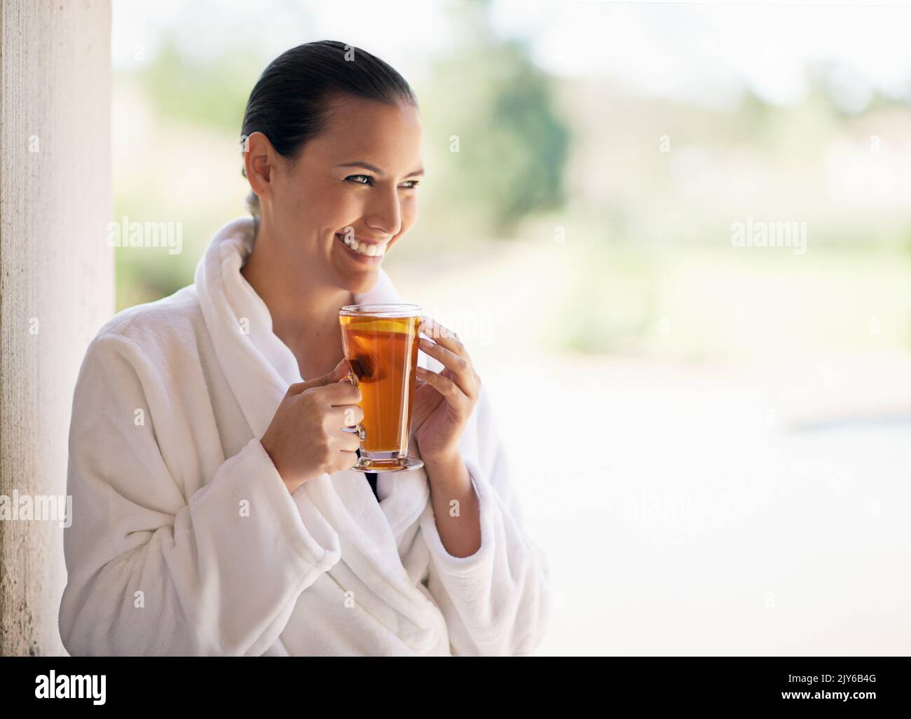 The spa is her sanctuary. a young woman drinking an iced tea at the day ...