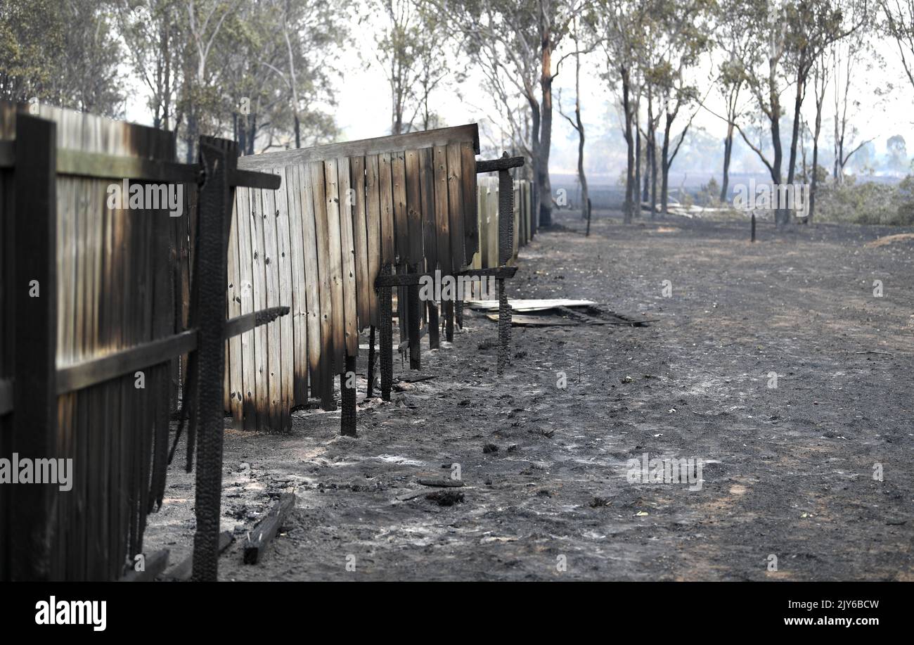 A fence damaged by bushfires is seen in Laidley, southeast Queensland ...