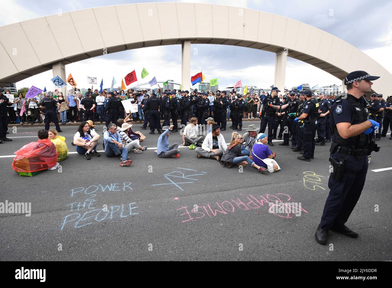 Activists from the Extinction Rebellion (XR) group sit with their hands ...