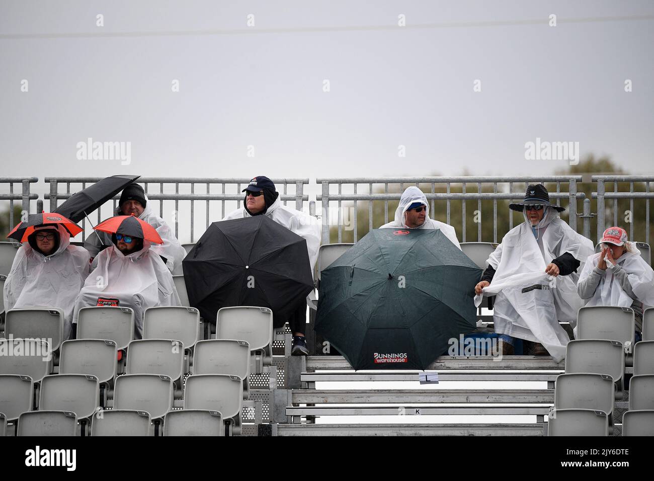 Racegoers take shelter as rain falls during the 2019 Bathurst 1000 at ...