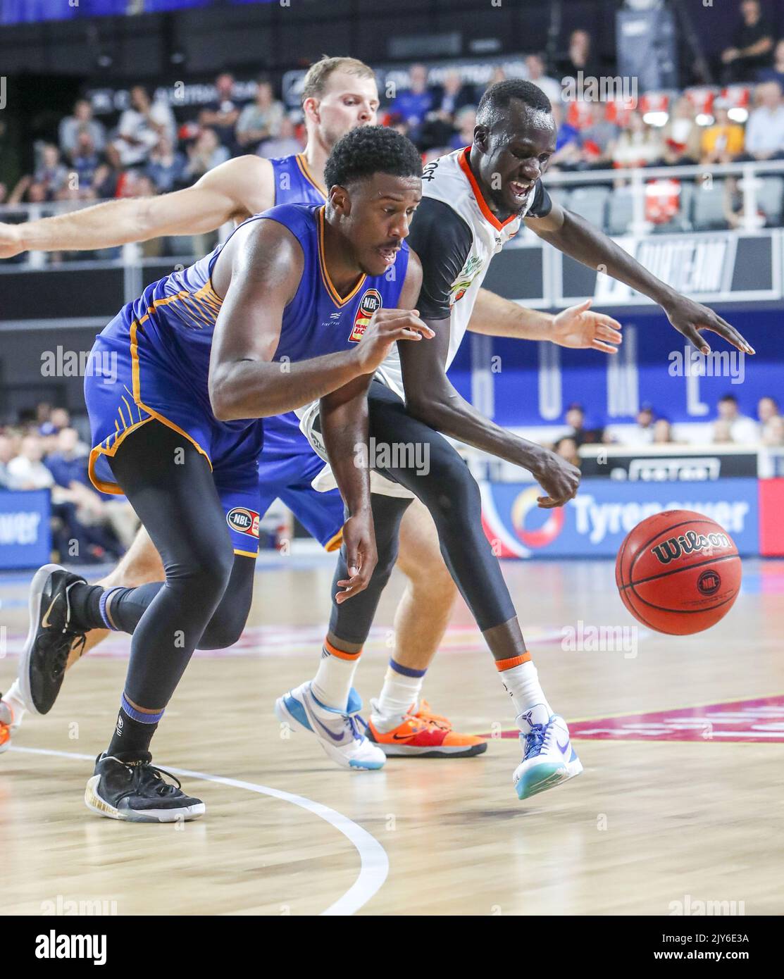 L-R, Lamar Patterson of the Bullets and Majok Deng of the Taipans chase ...