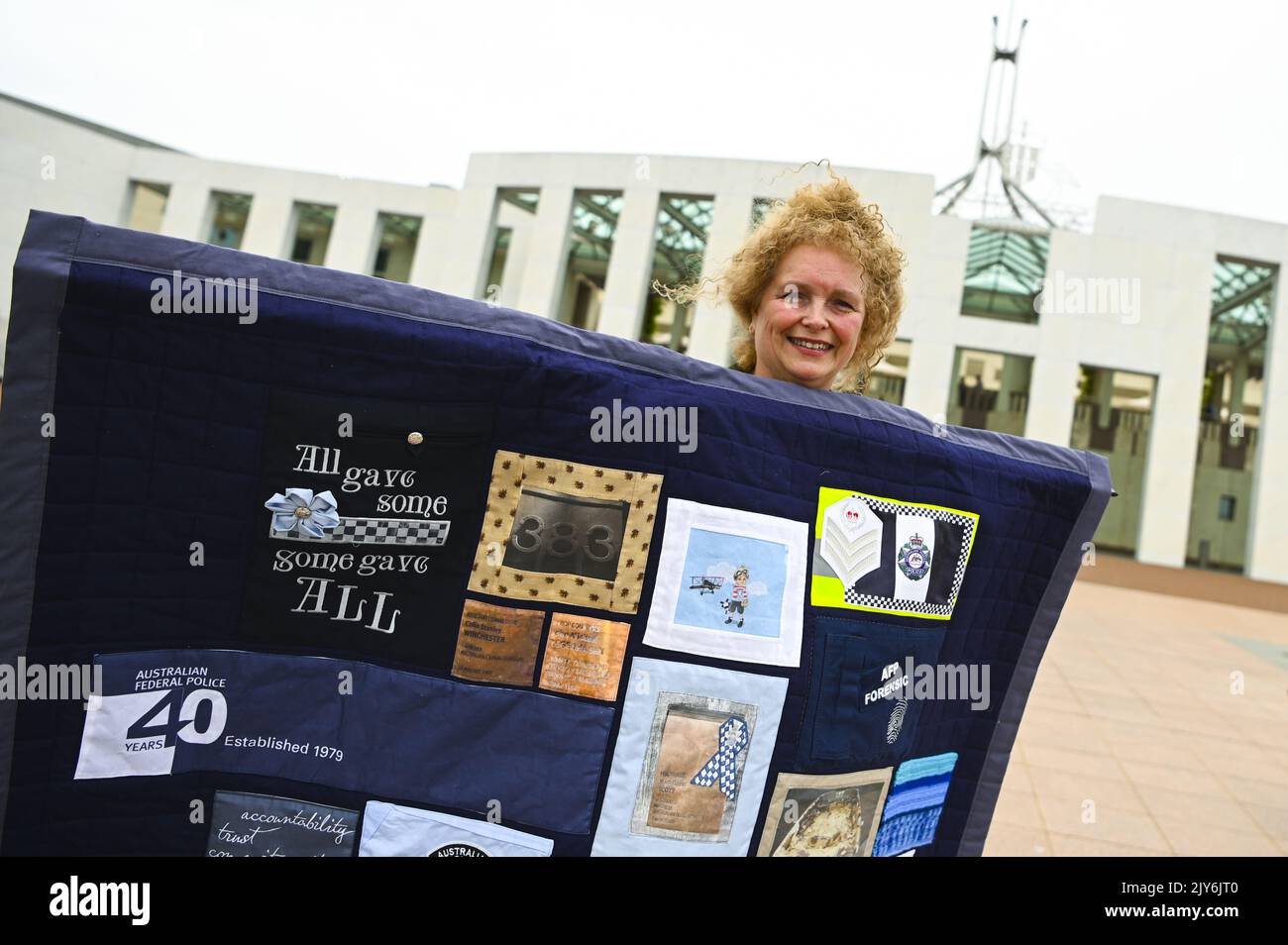 AFP museum curator Chris Cranston poses for photographs with one of the ...