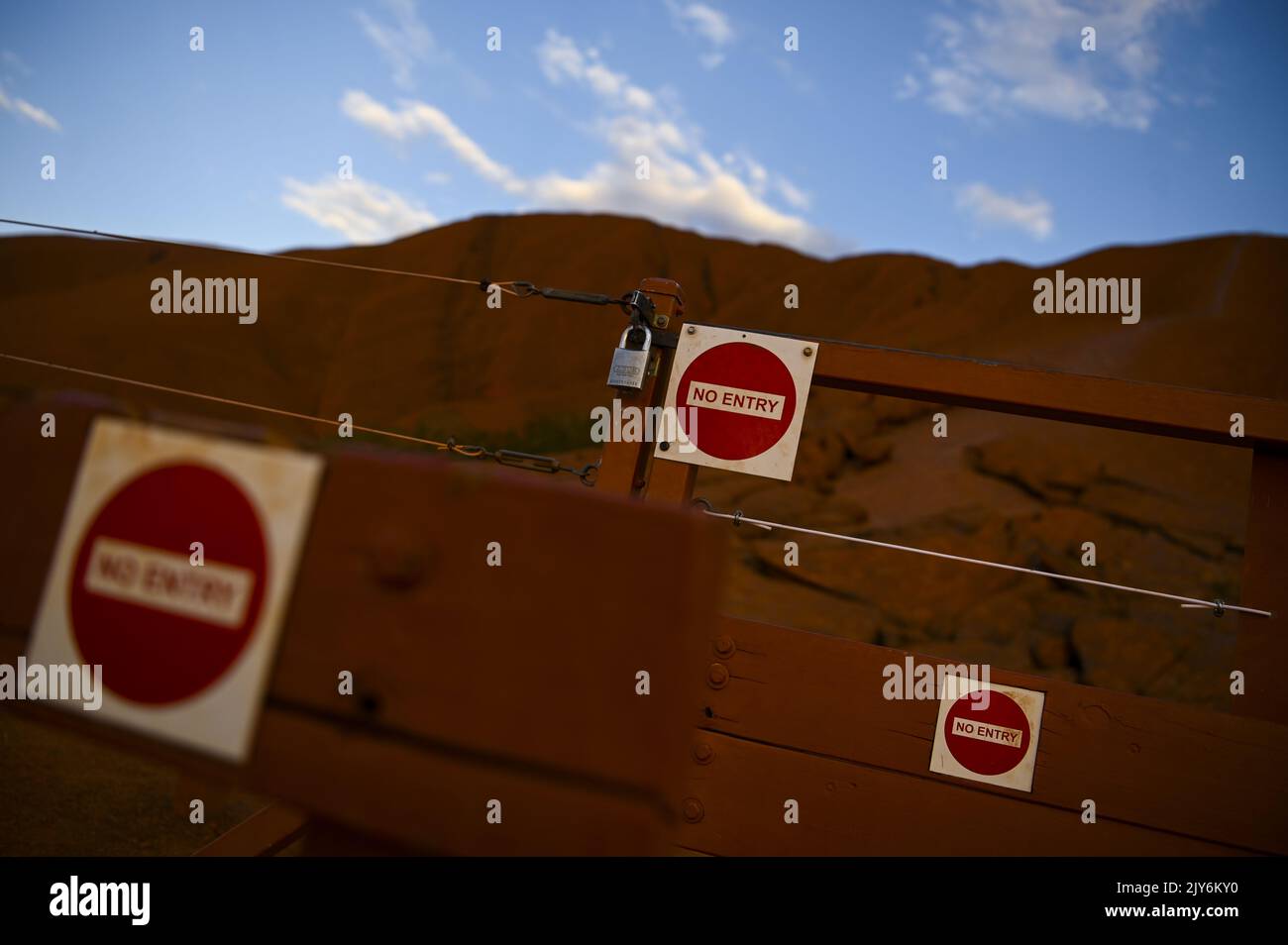 The locked gate to the climbing area at Uluru, also known as Ayers Rock ...