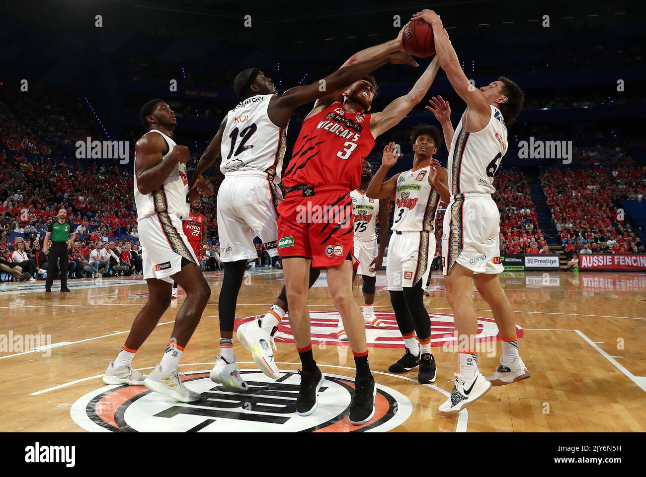 Nicholas Kay of the Wildcats battles for the ball with Kouat Noi and ...