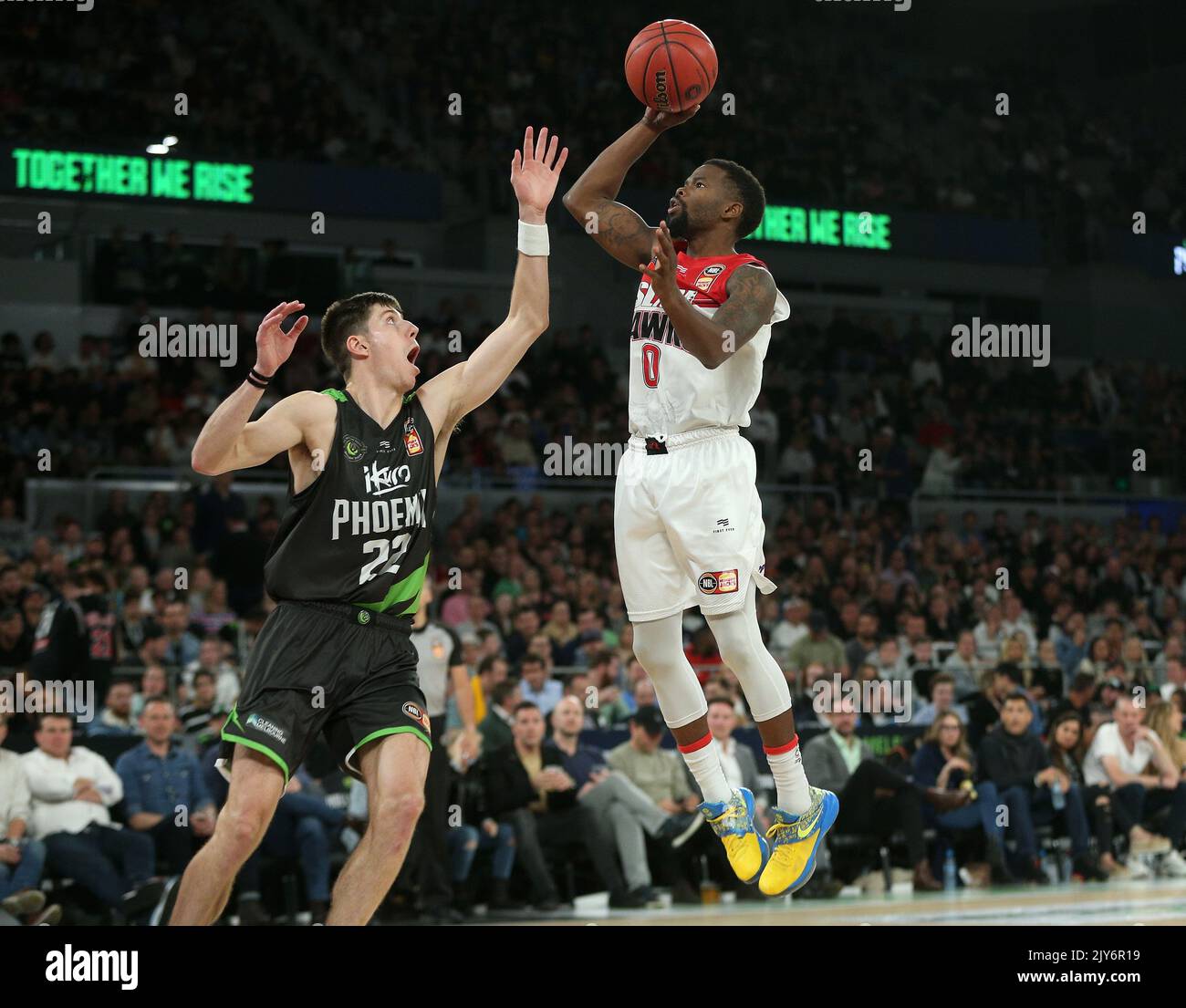Aaron Brooks of Illawarra shoots over Dane Pineau of the Phoenix during ...