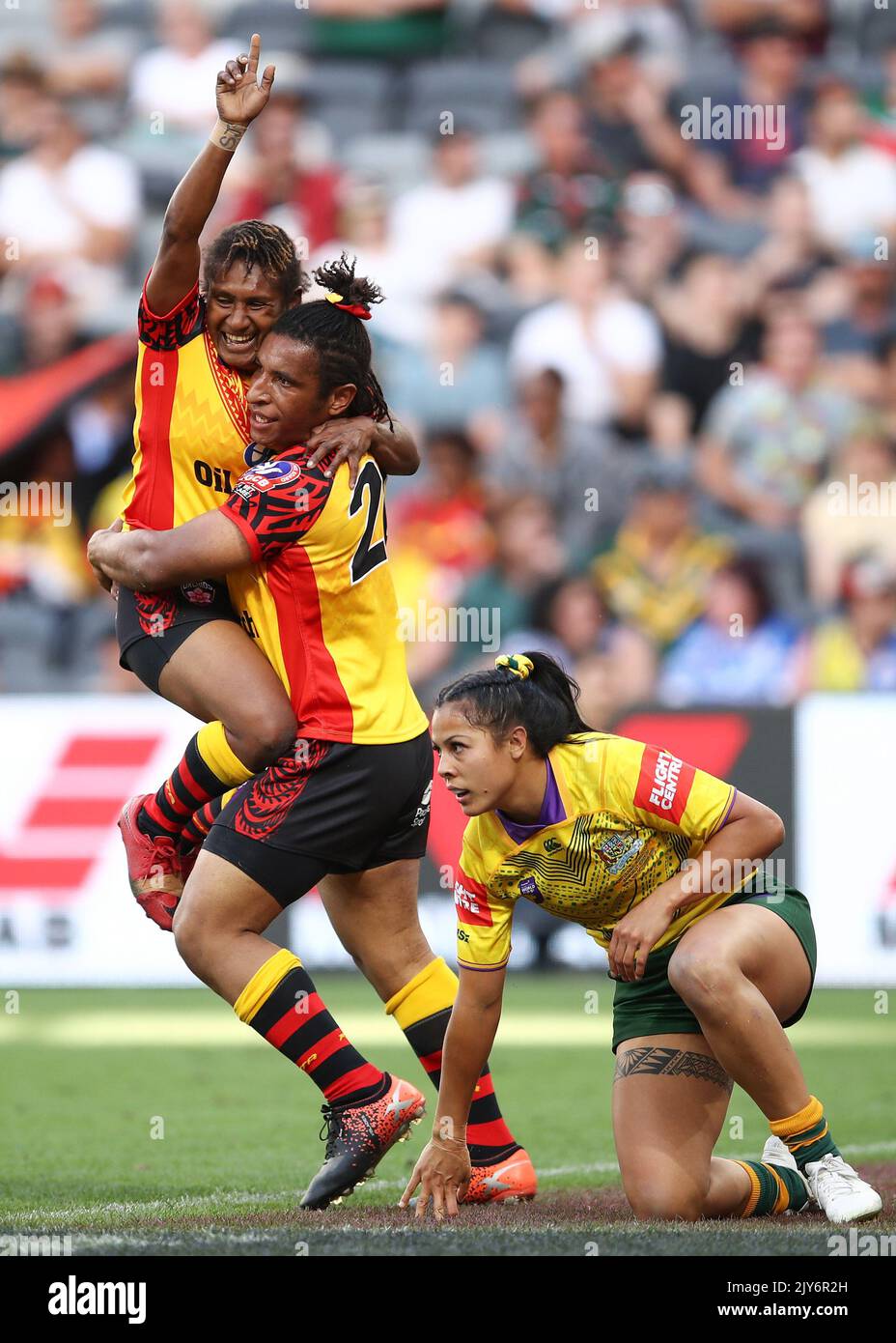 Elsie Albert of PNG celebrates scoring a try with team mates in the ...