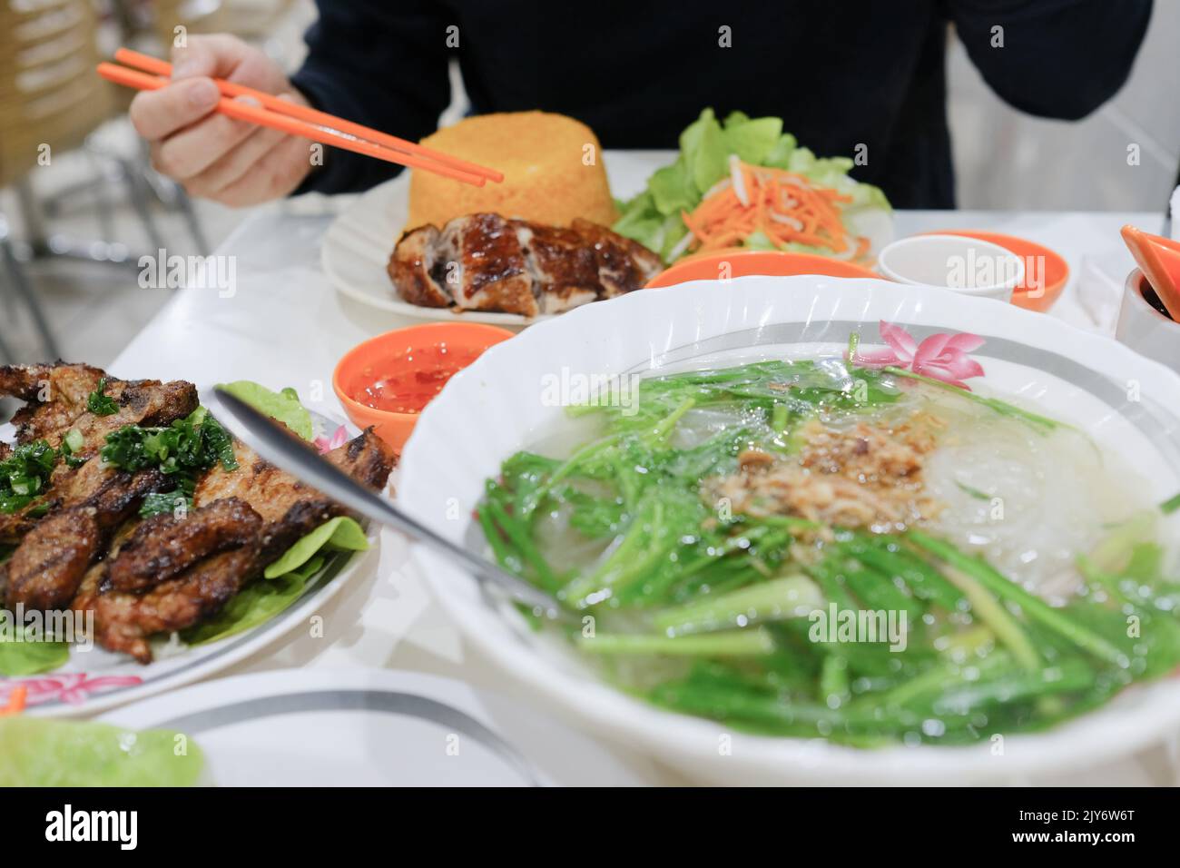 Grilled pork chop with rice noodles and crispy skin chicken with tomato ...