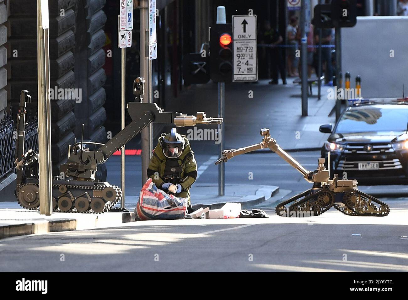 A Bomb Response Unit officer inspects a bag on Little Collins Street in ...