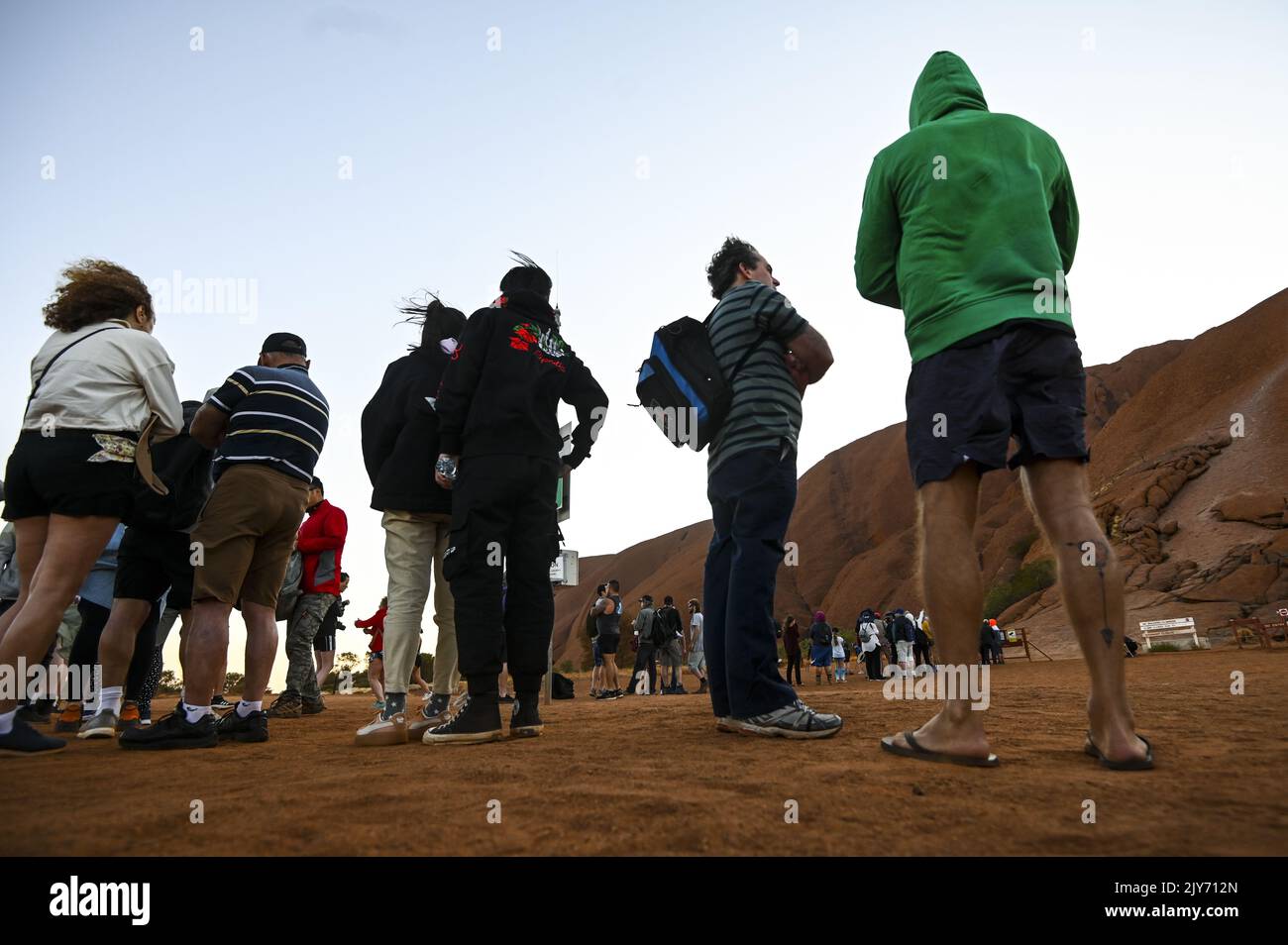 Tourists are seen lining up to climb Uluru, also known as Ayers Rock at ...