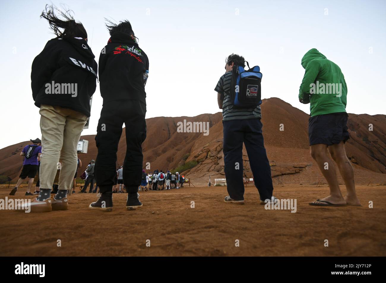 Tourists are seen lining up to climb Uluru, also known as Ayers Rock at ...