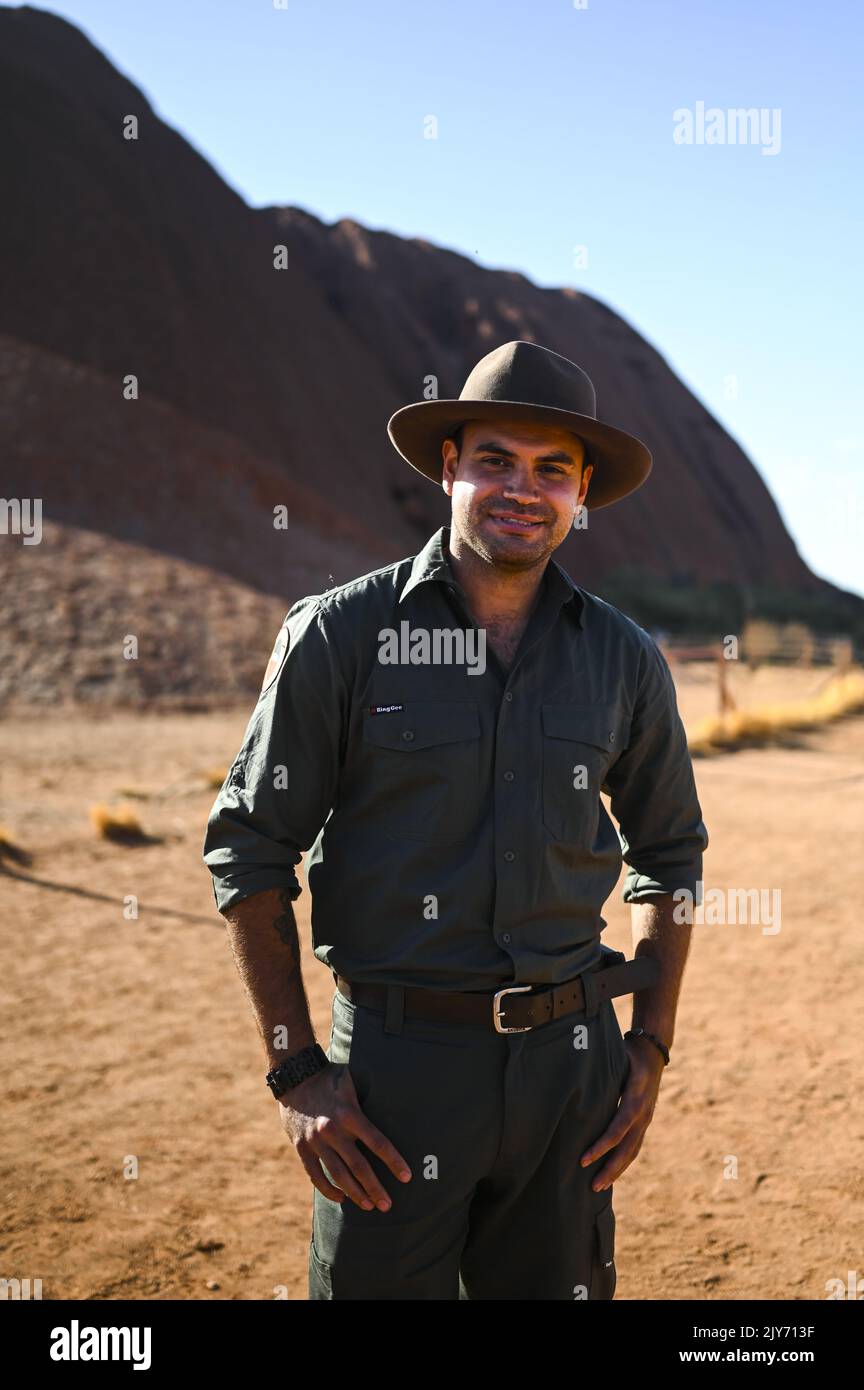 Aboriginal ranger Tjiangu Thomas poses for photographs at Uluru, also ...