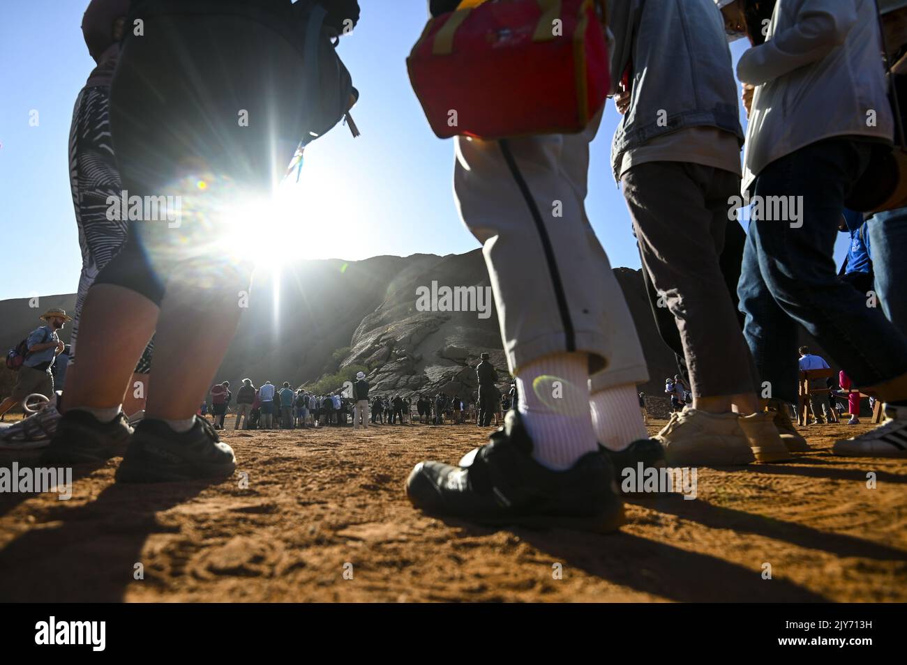 Tourists are seen lining up to climb Uluru, also known as Ayers Rock at ...