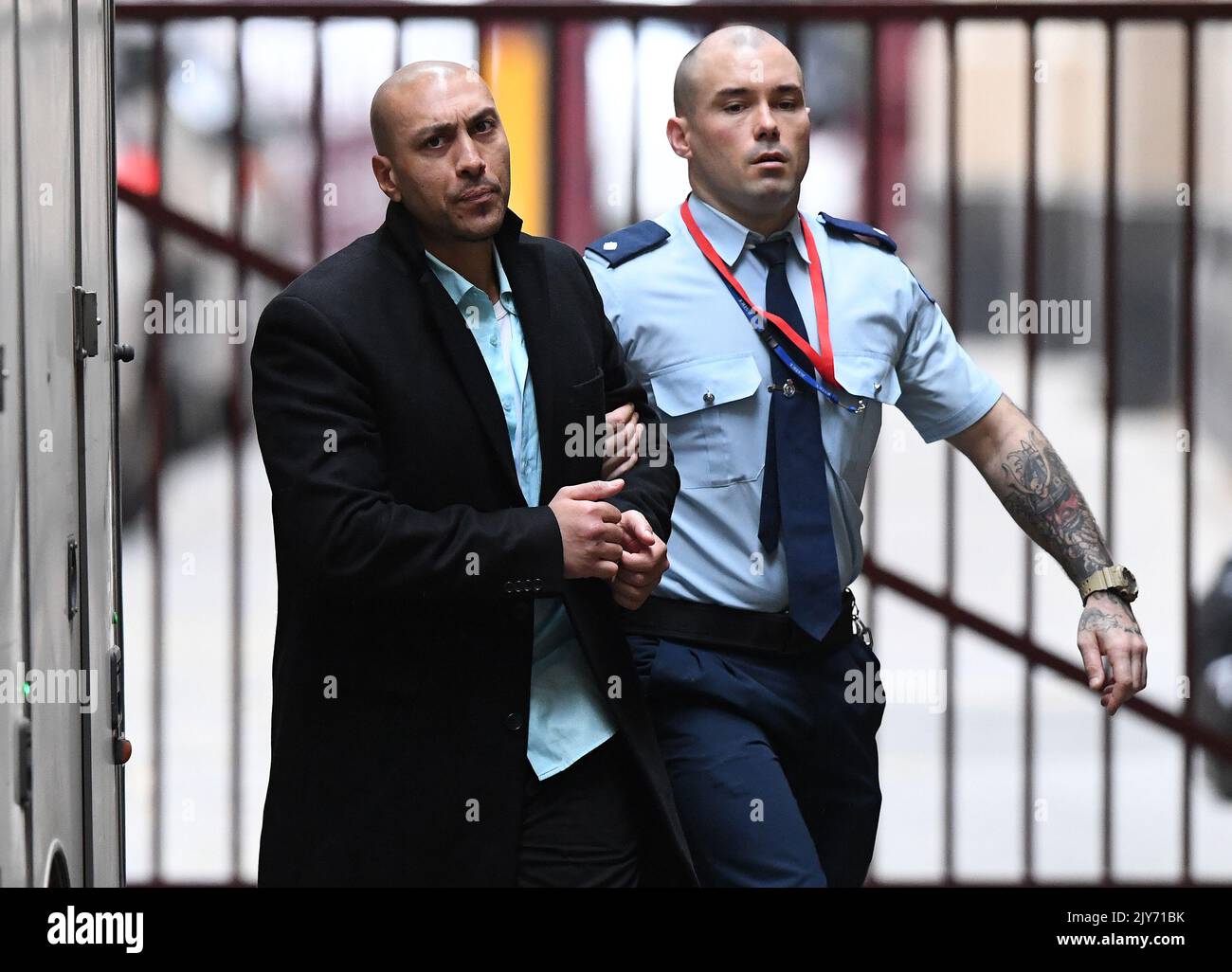 Albert Awad (left) is taken into the Supreme Court of Victoria in ...
