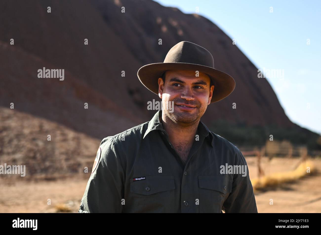Aboriginal ranger Tjiangu Thomas poses for photographs at Uluru, also ...