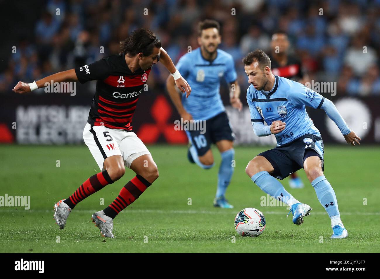 Adam Le Fondre of Sydney competes with Daniel Georgievski of the ...