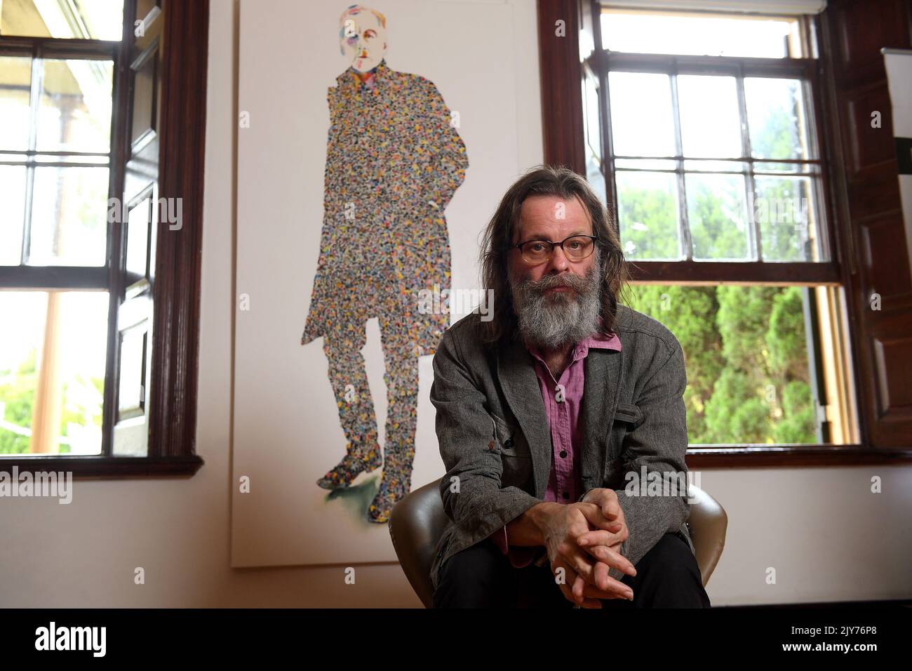 Australian artist 'What' poses for a photograph with his work Robert ...