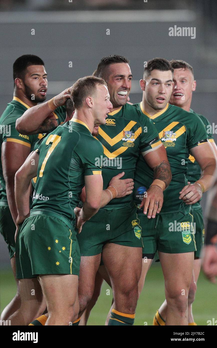 Paul Vaughan of Australia, centre, is congratulated on scoring a try ...