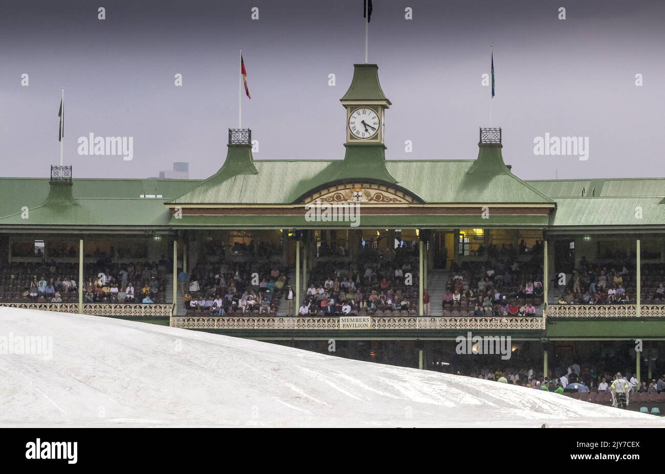 Ground keepers pull the covers on during the T20 International cricket ...