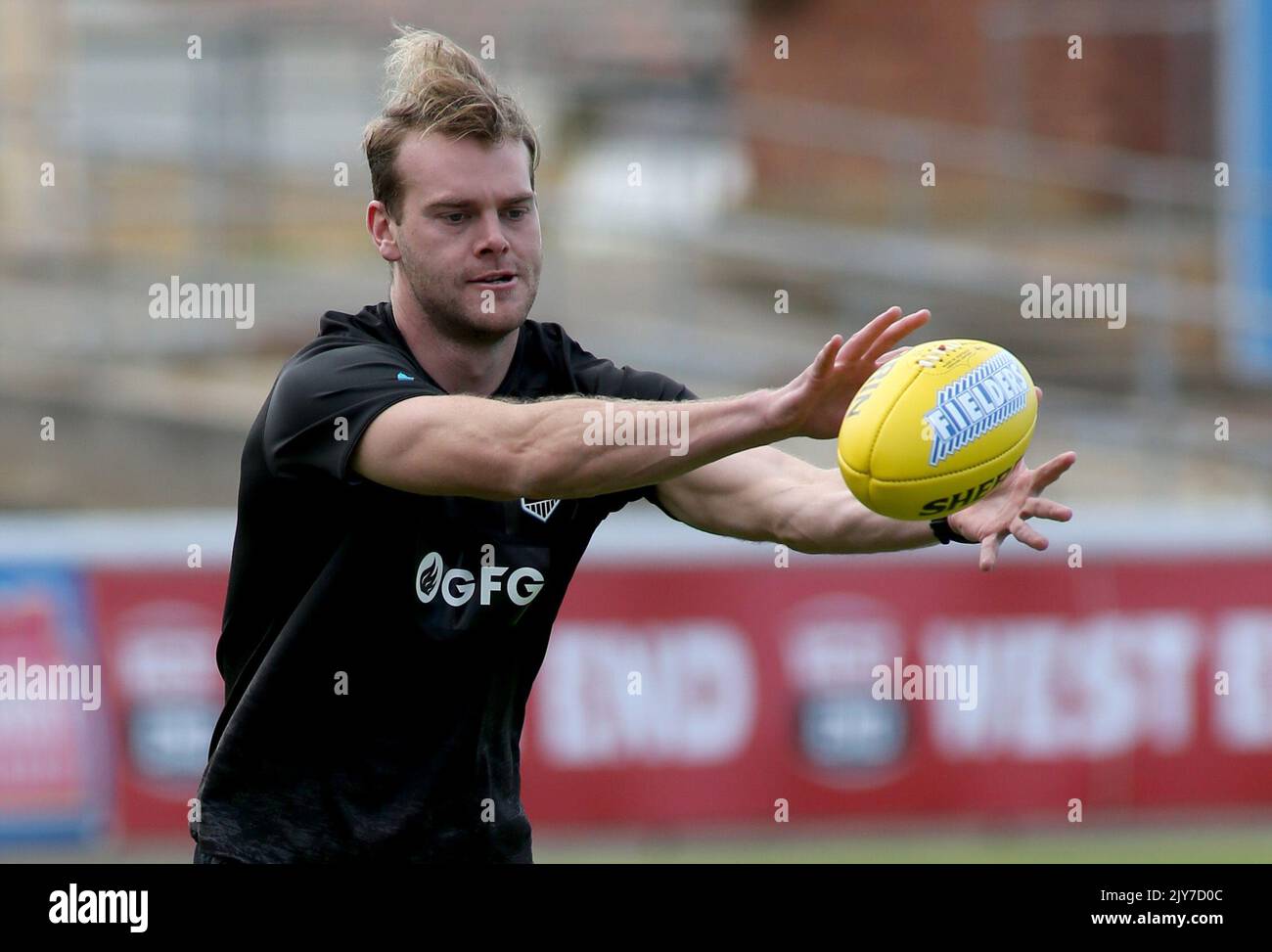 Jack Watts takes part in warm ups with a small group of first to fourth ...