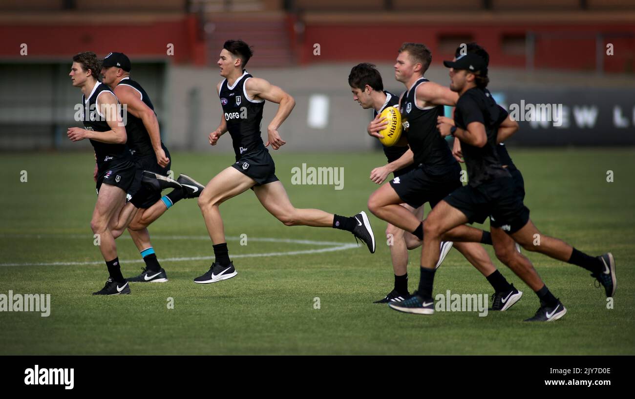 Connor Rozee takes part in warm ups with a small group of first to ...