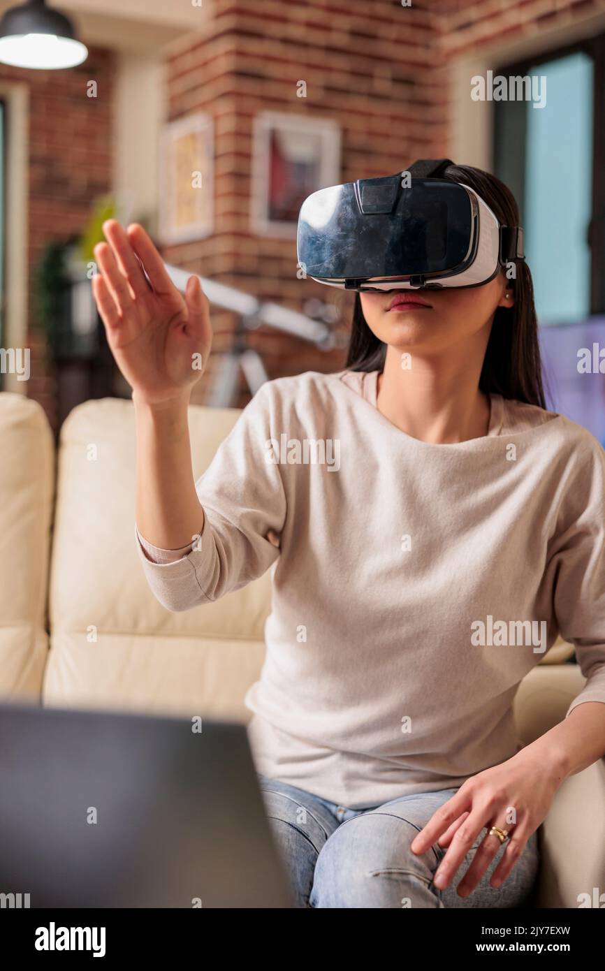 Happy asian woman enjoying wearing VR virtual reality headset, modern ...