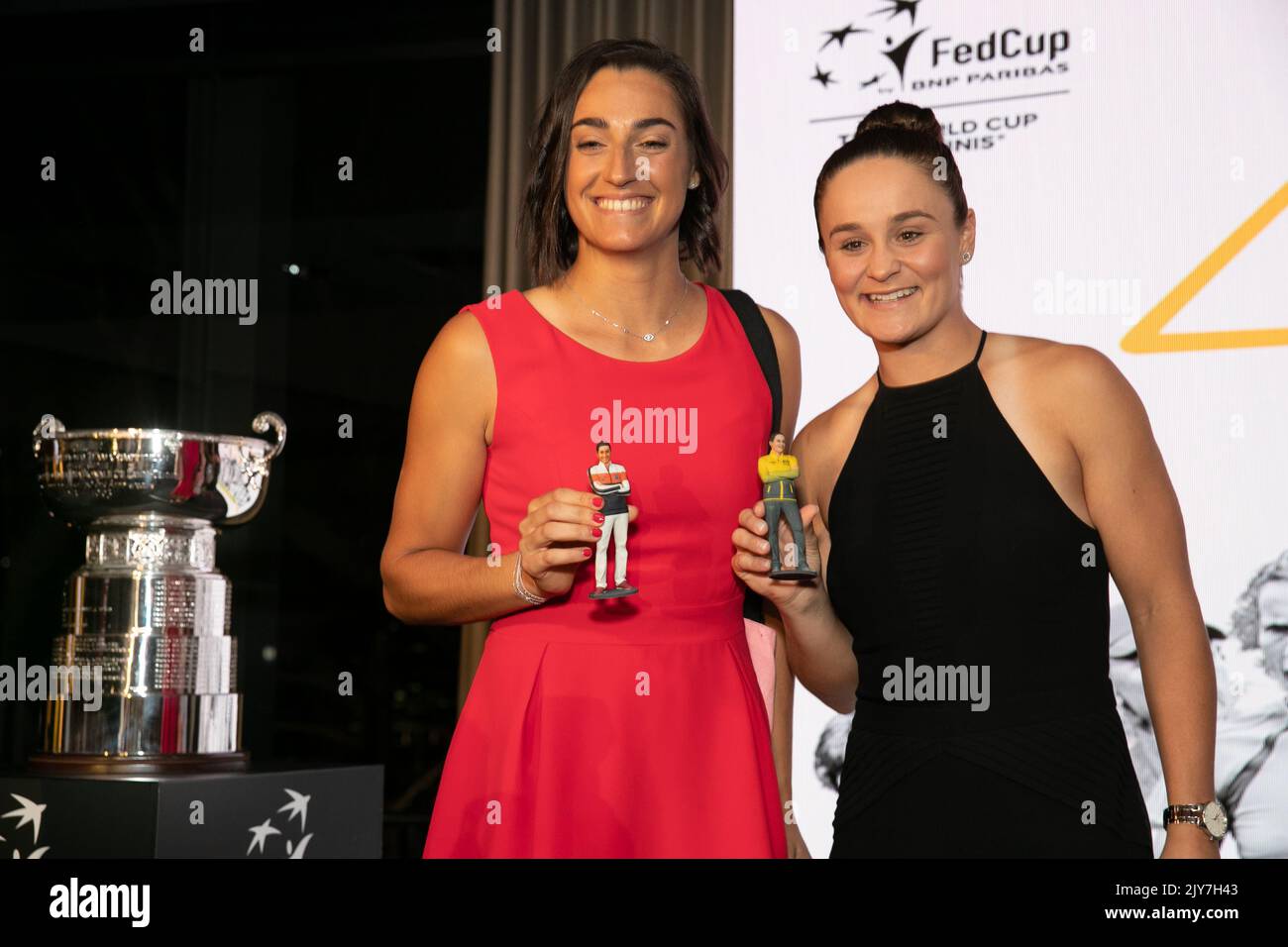 Caroline Garcia and Ash Barty hold the gifts the teams gave each other ...